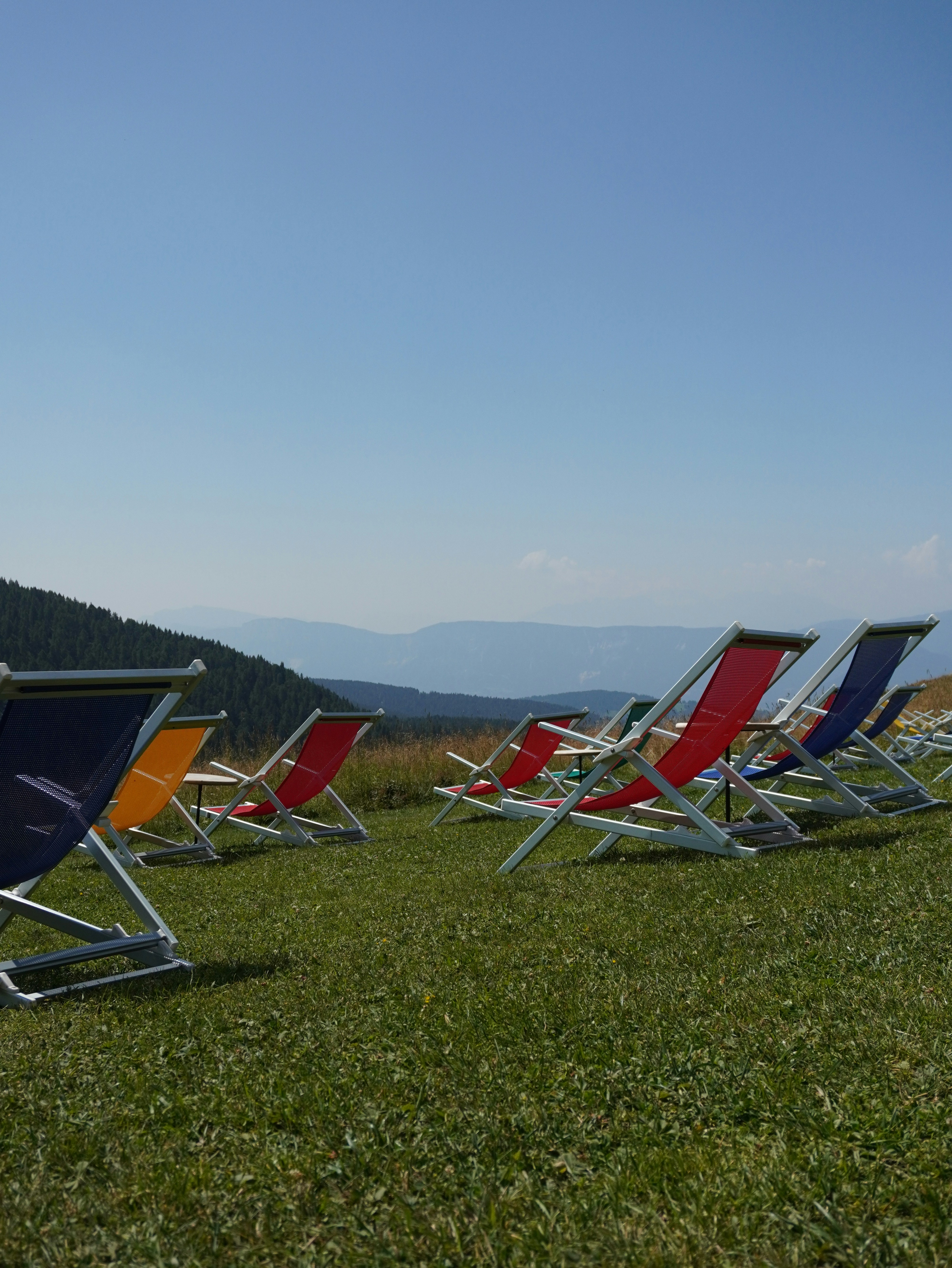 Row of Colorful Beach Chairs Under a Clear Sky