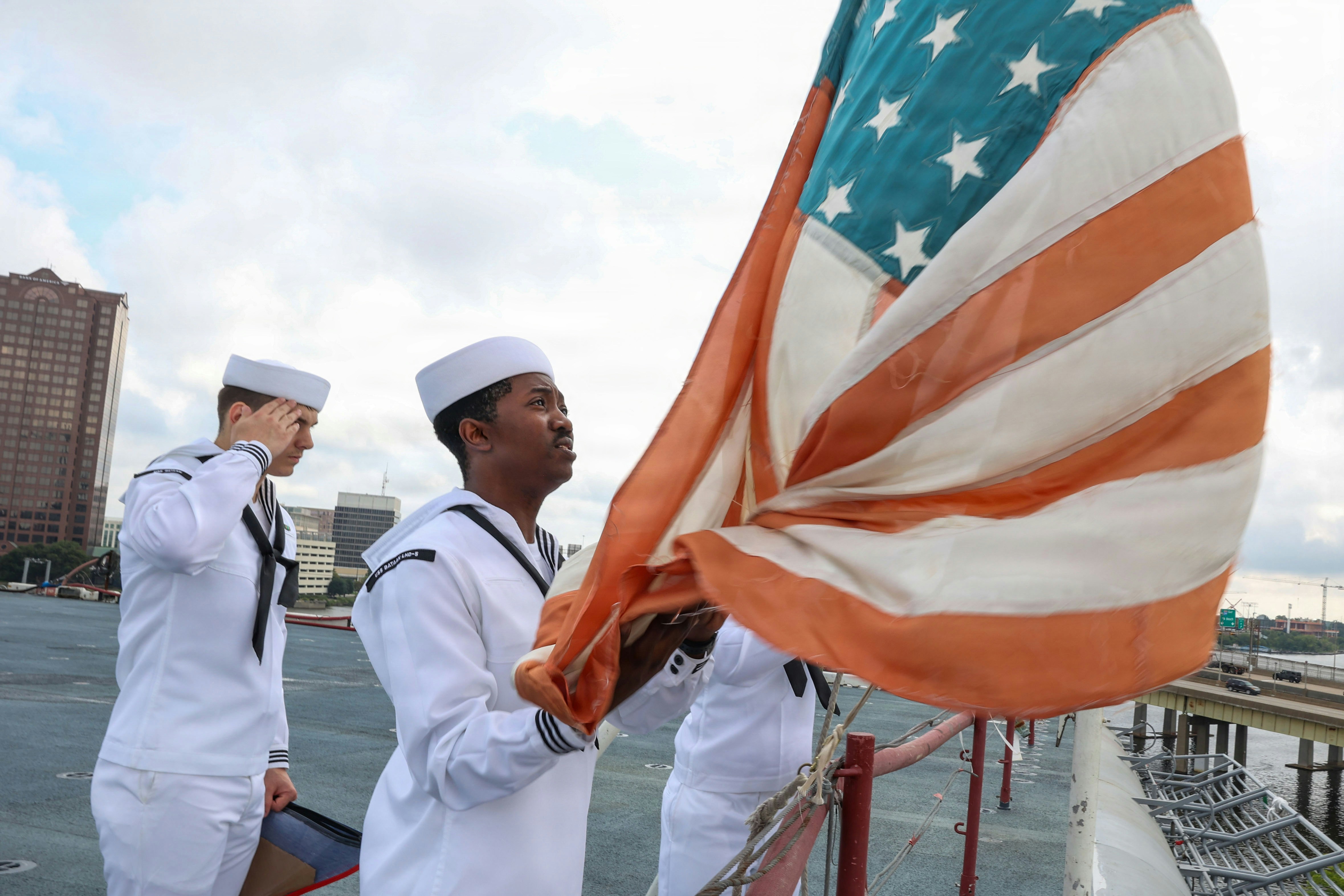 Sailors Raise a Flag over the Waterfront