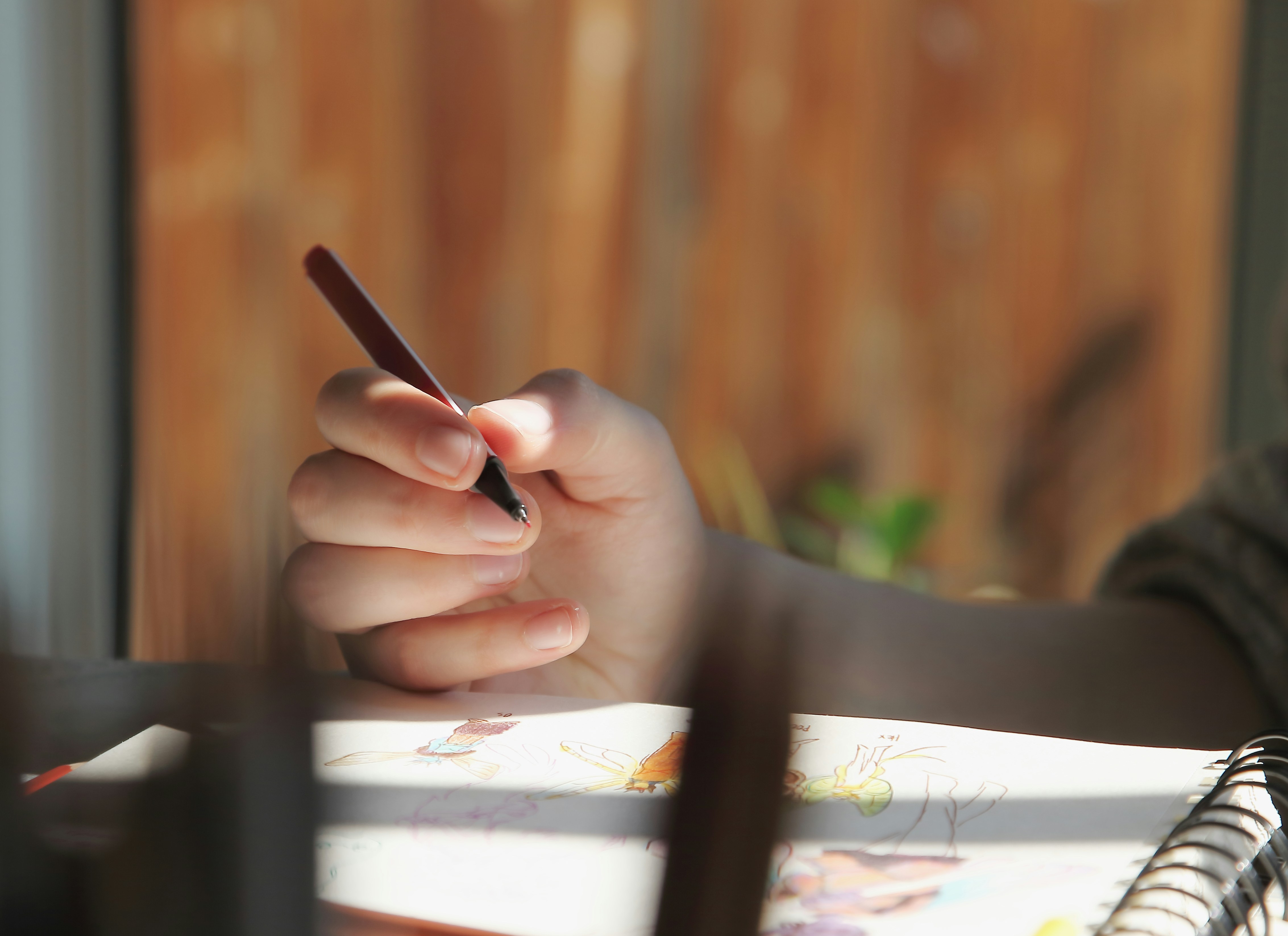 Ink Between Fingers: A Quiet Moment Over a Sketchbook