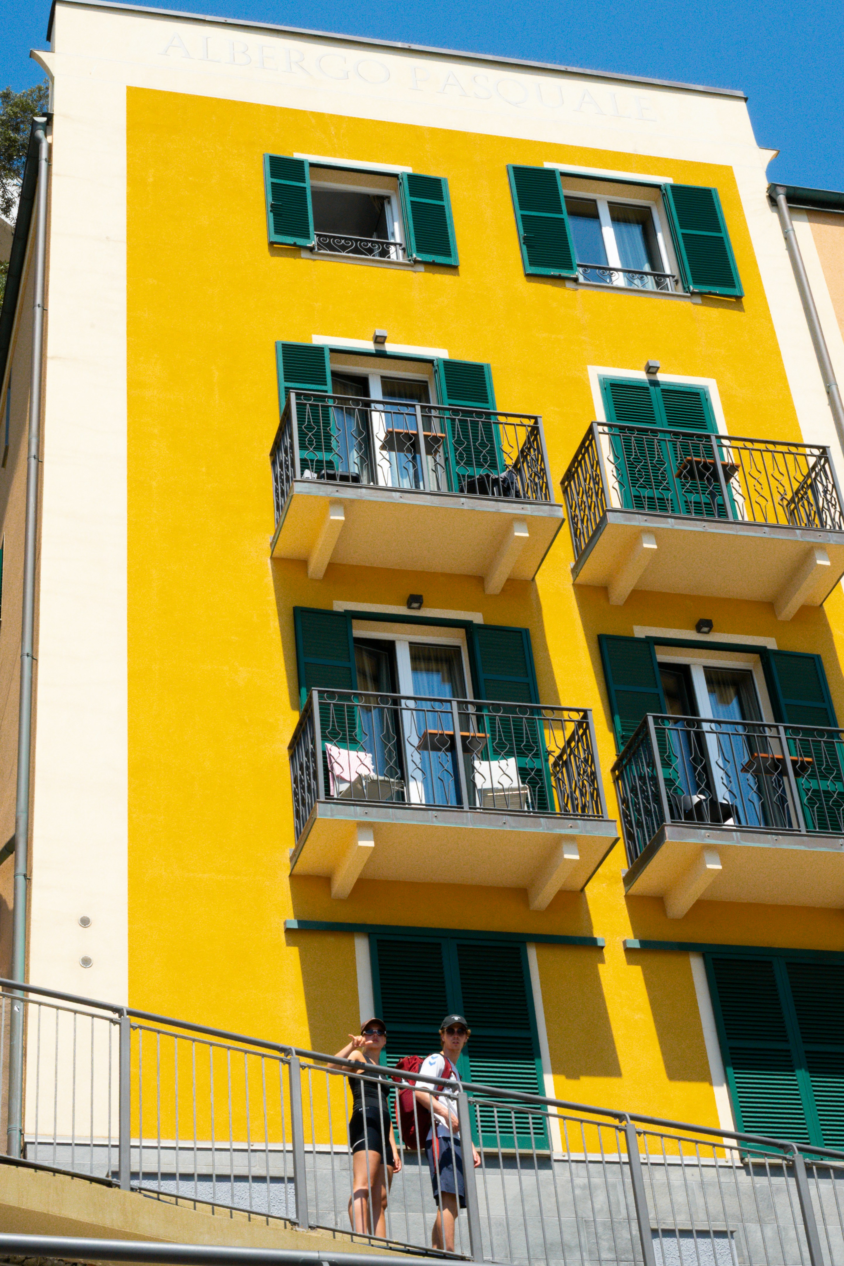 Yellow Facade and Balcony Echoes: A Sunlit Italian Getaway