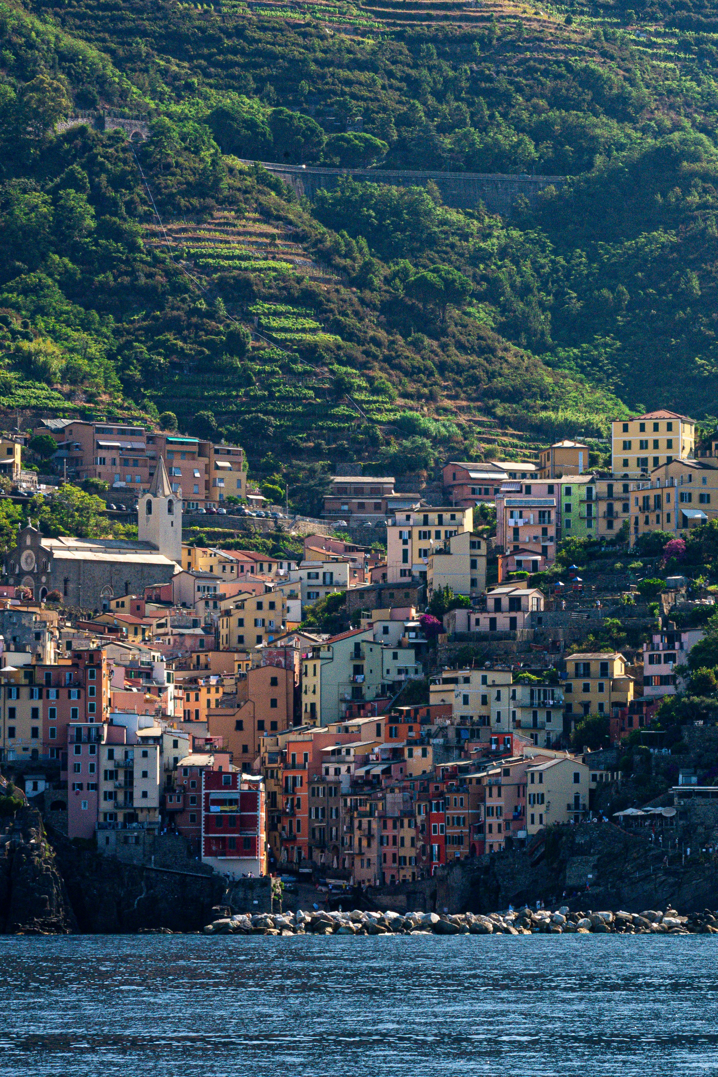Colored hillside village at the edge of a rocky coastline
