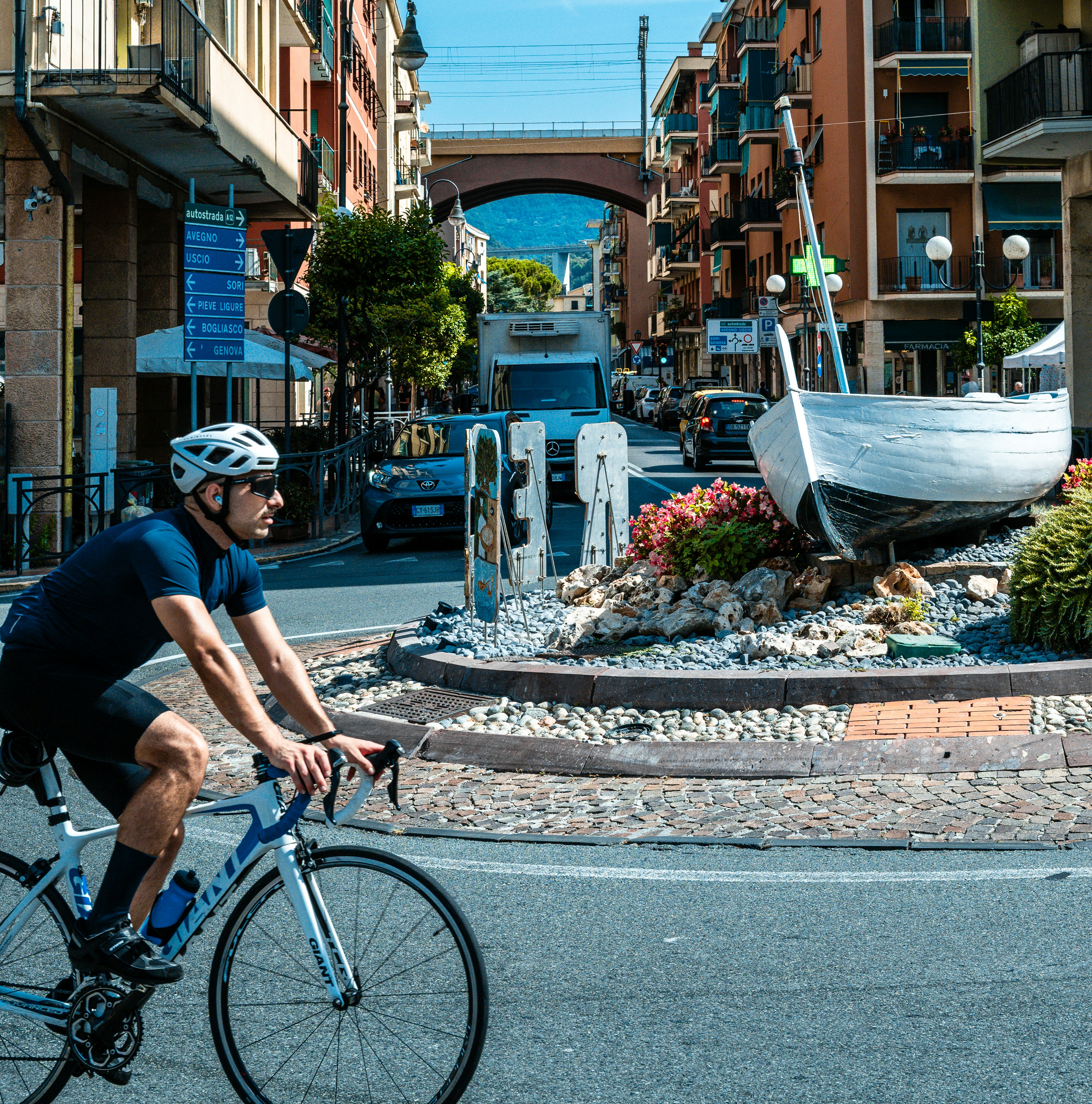 Rider in Focus: A Street Circuit Beneath a Seaside Arc