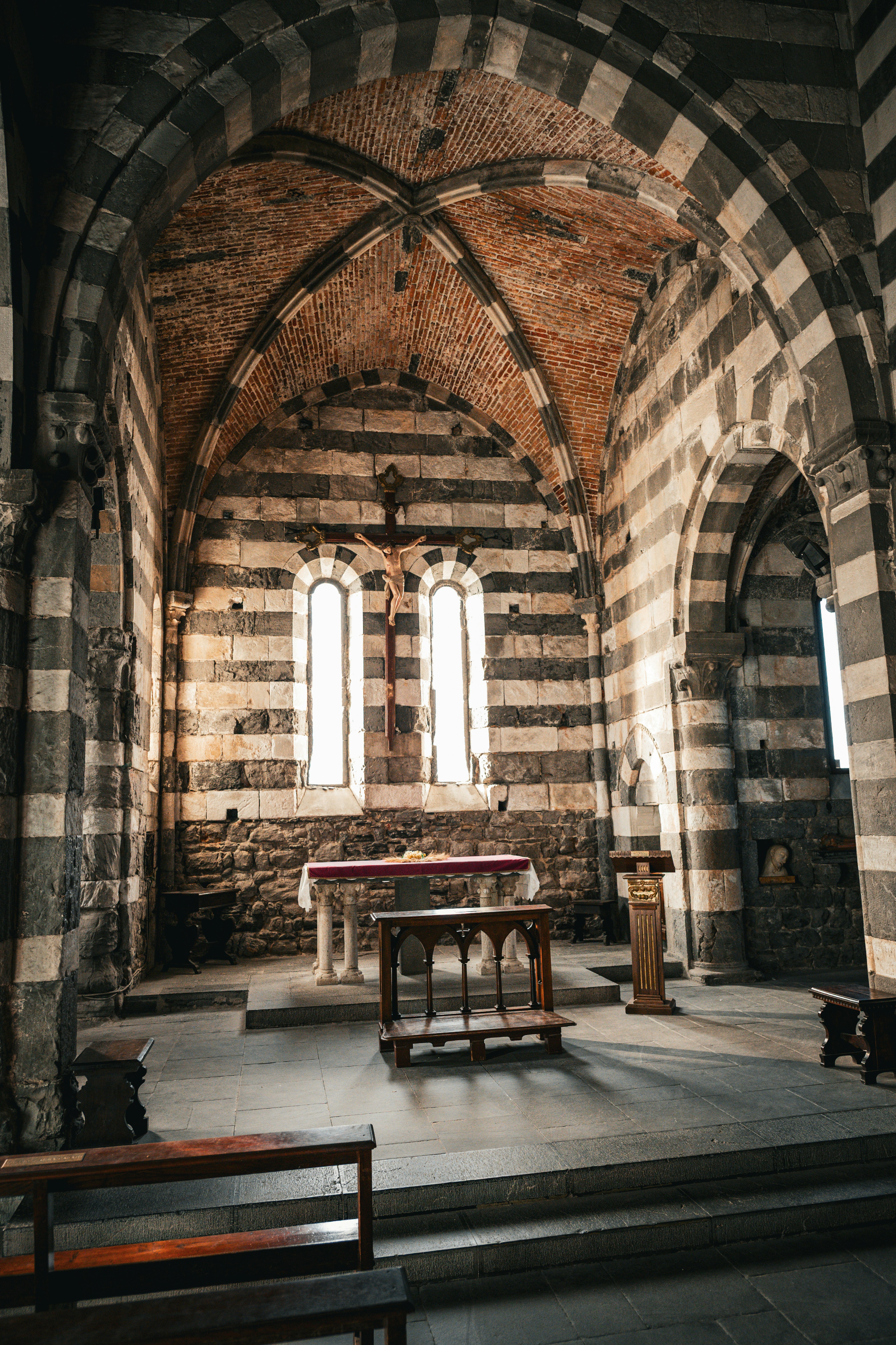 Striped Gothic Interior: altar, arches, and crucifix Framed by Horizontal Bands