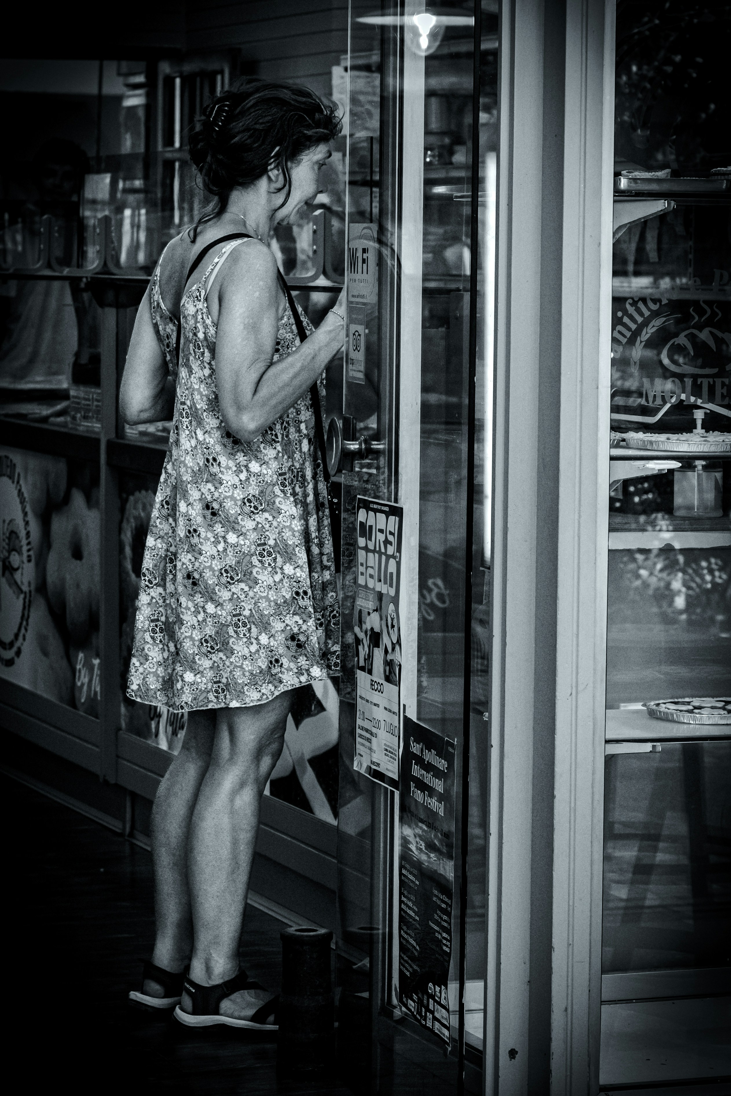 Candlelit Pause: A Quiet Moment at the Shopfront Door