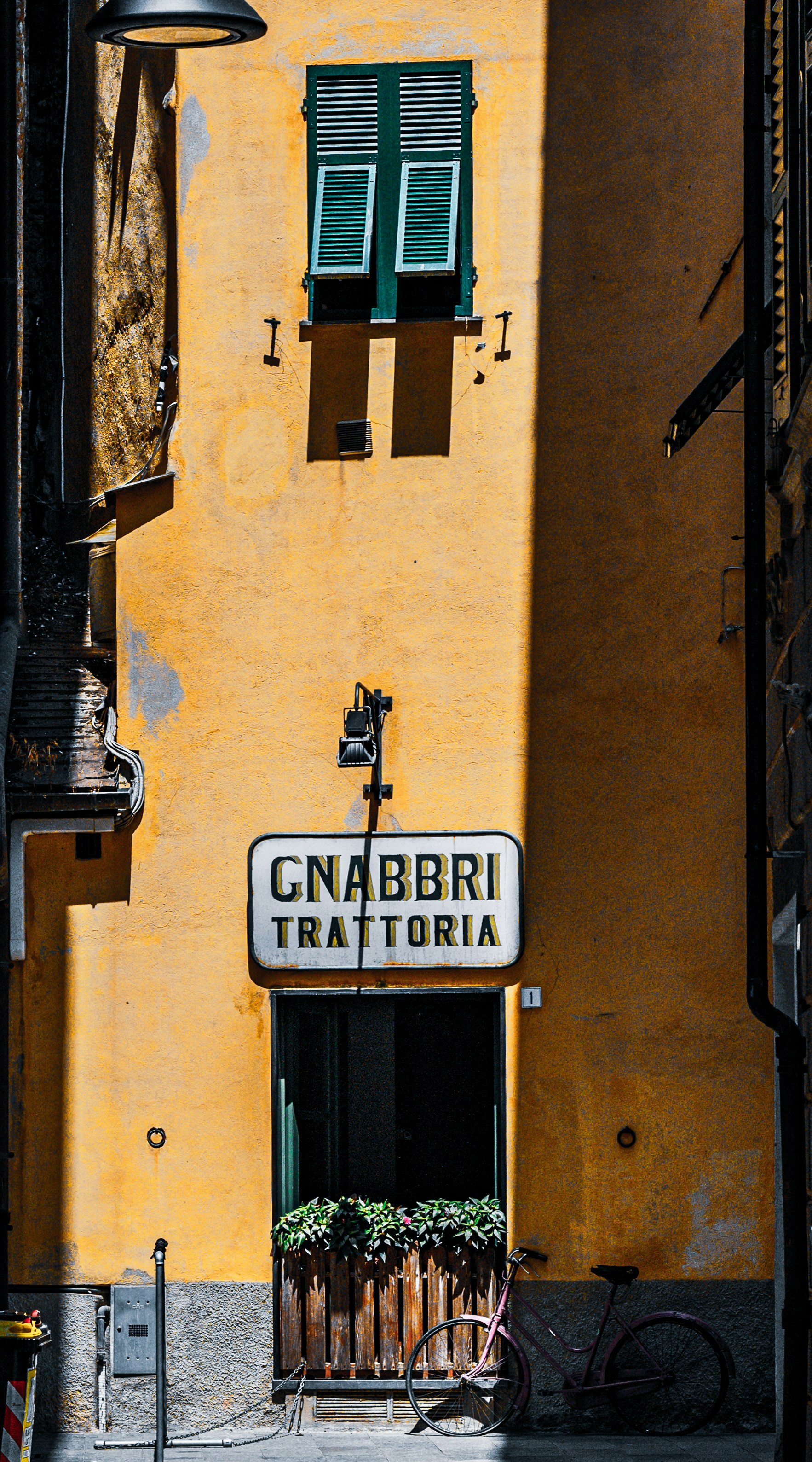 Sunlit Facade of Gnabbrì Trattoria: A Narrow Street’s Quiet Anchor