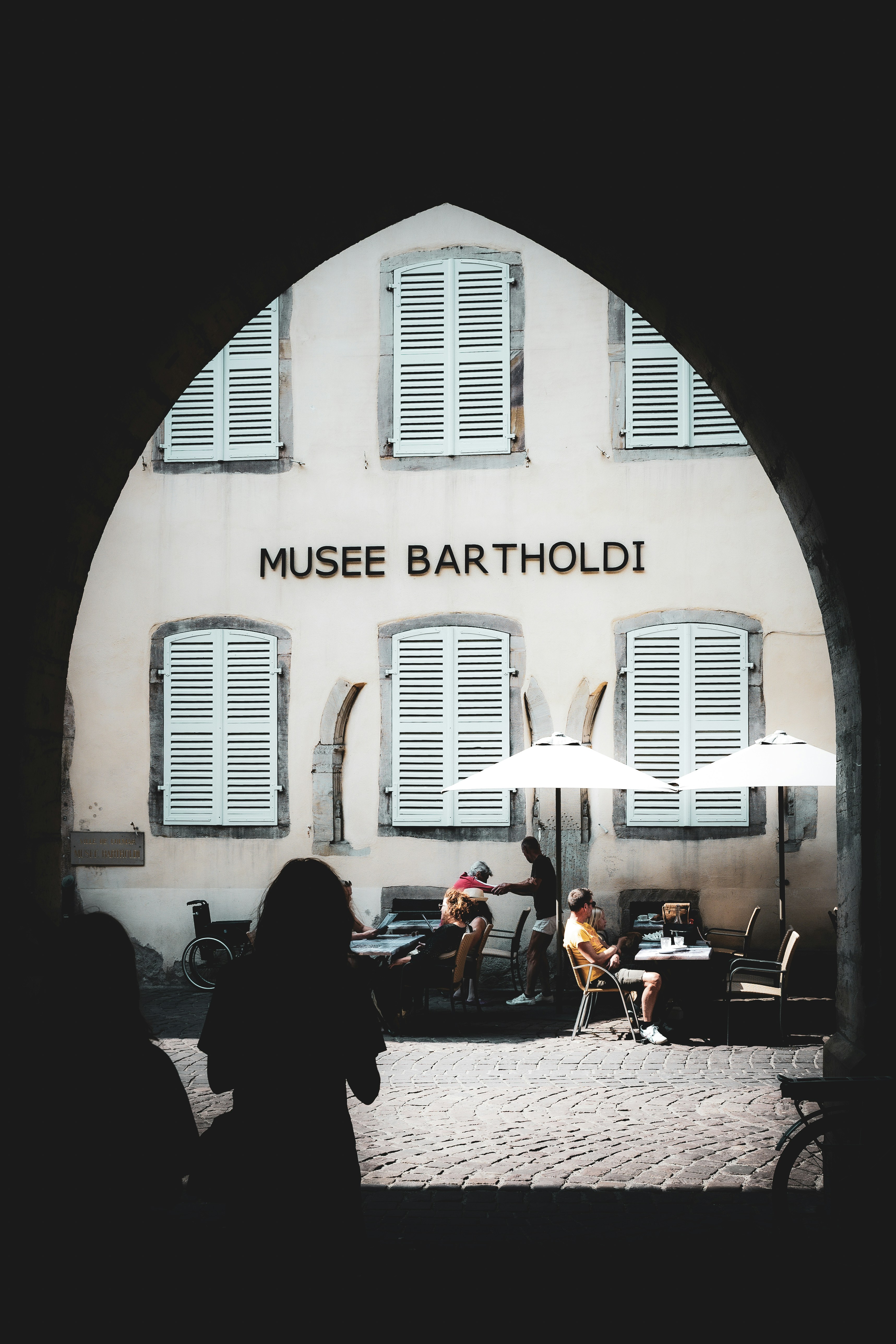 Courtyard Café Beneath a Stone Arch