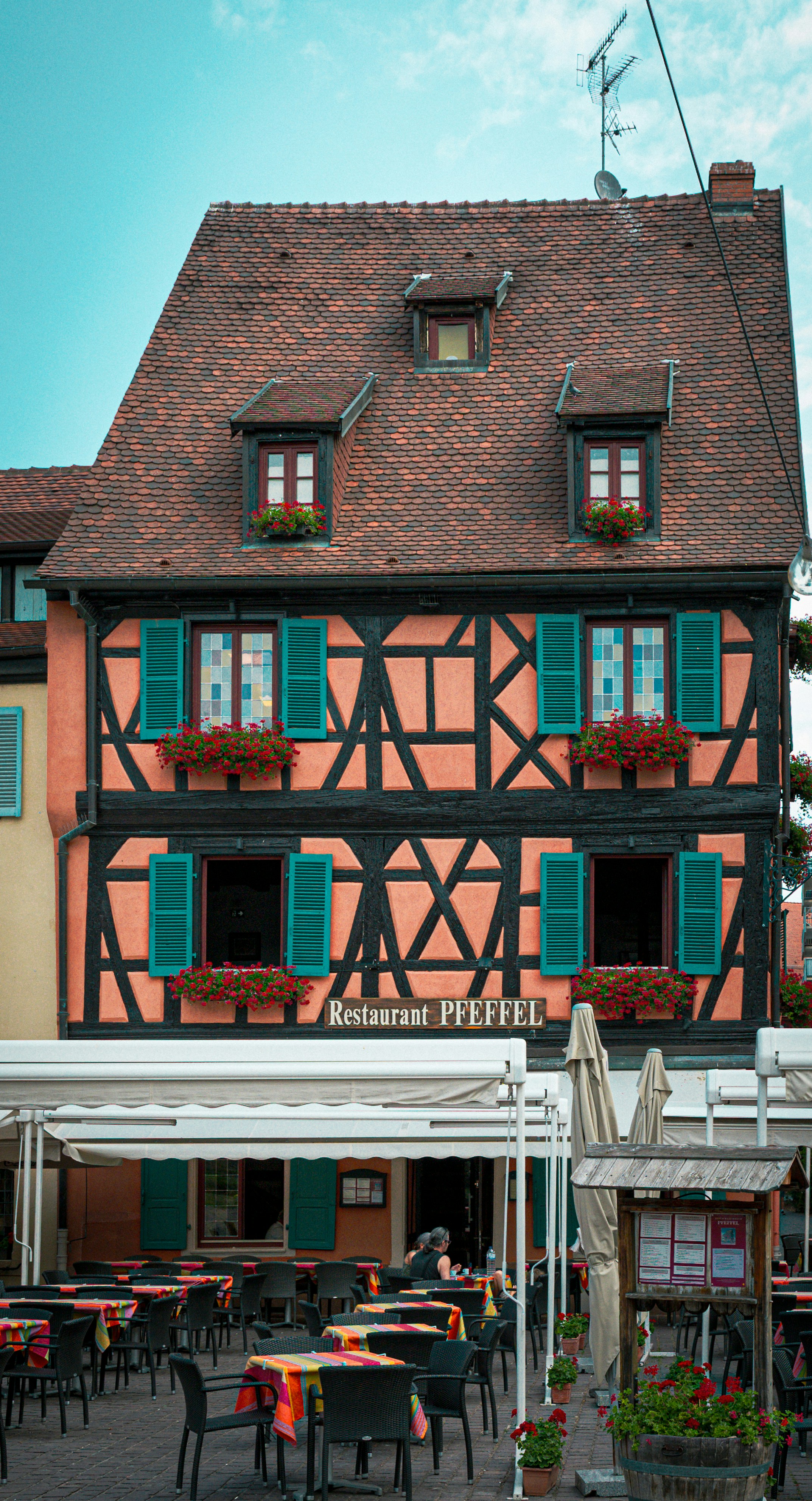 Timber-framed Terrace: A Tepid Summer Meal Under Colorful Shutters