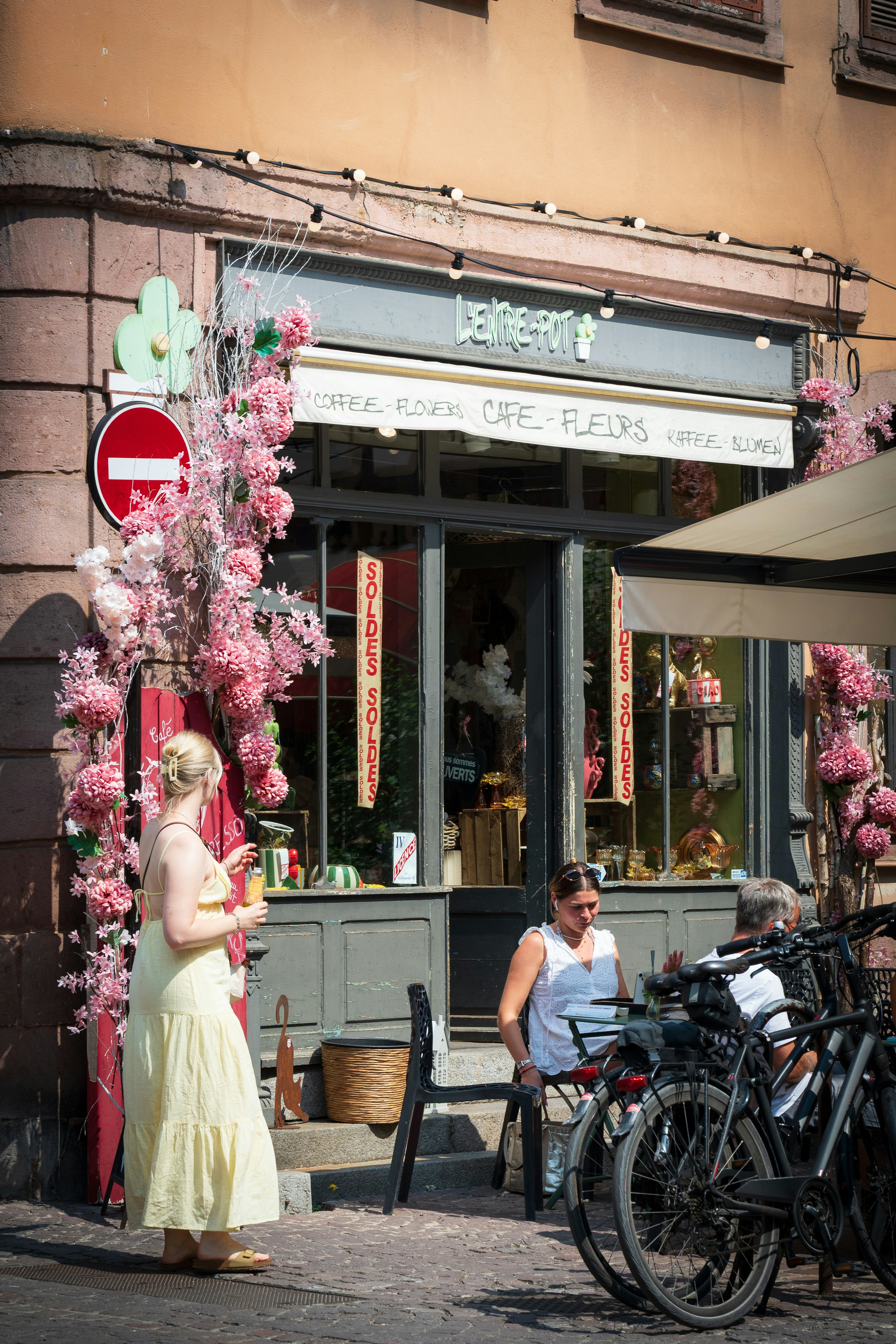 Sunlit Café Façade in Bloom