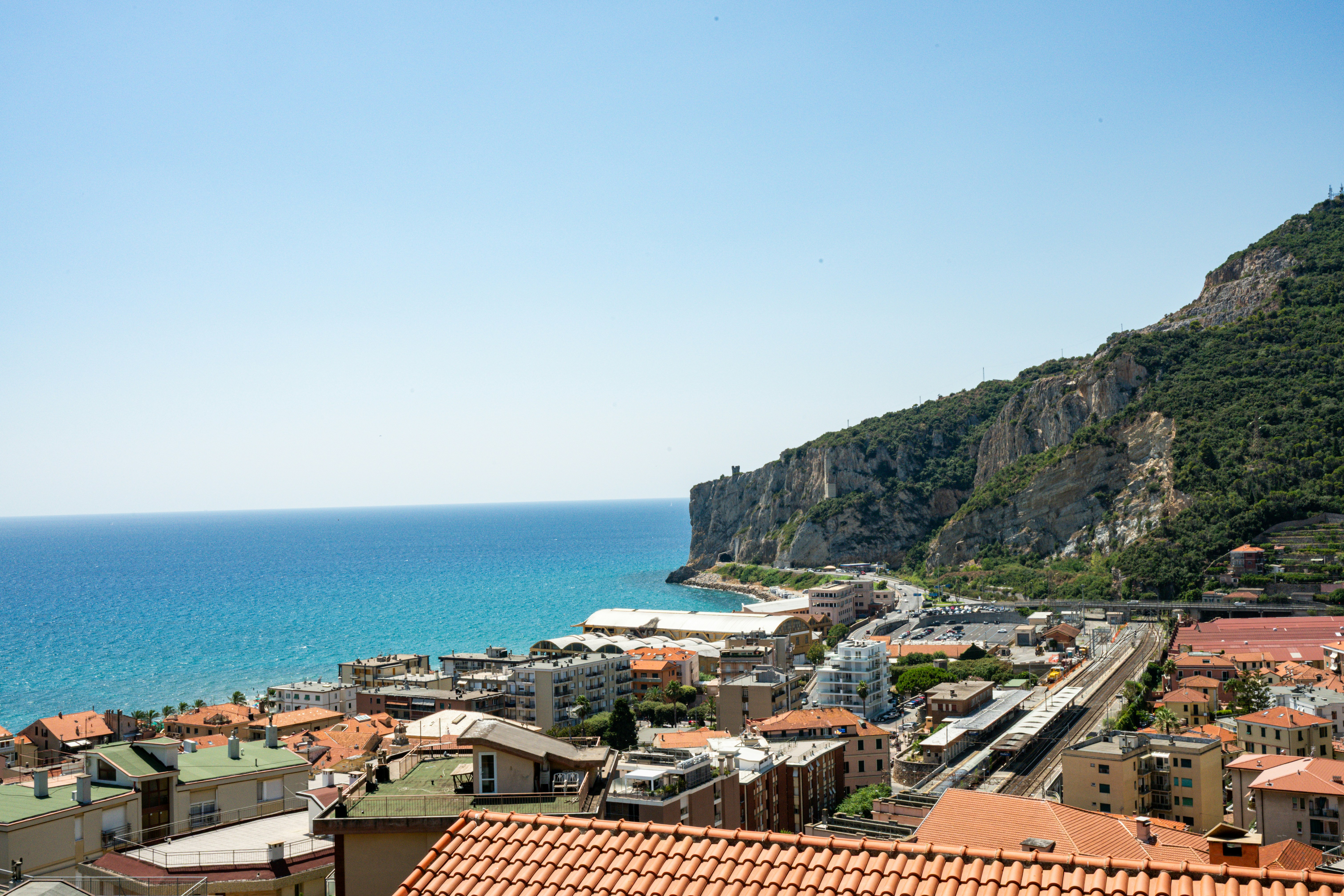 Coastal town at the edge of a cliff overlooking a calm sea