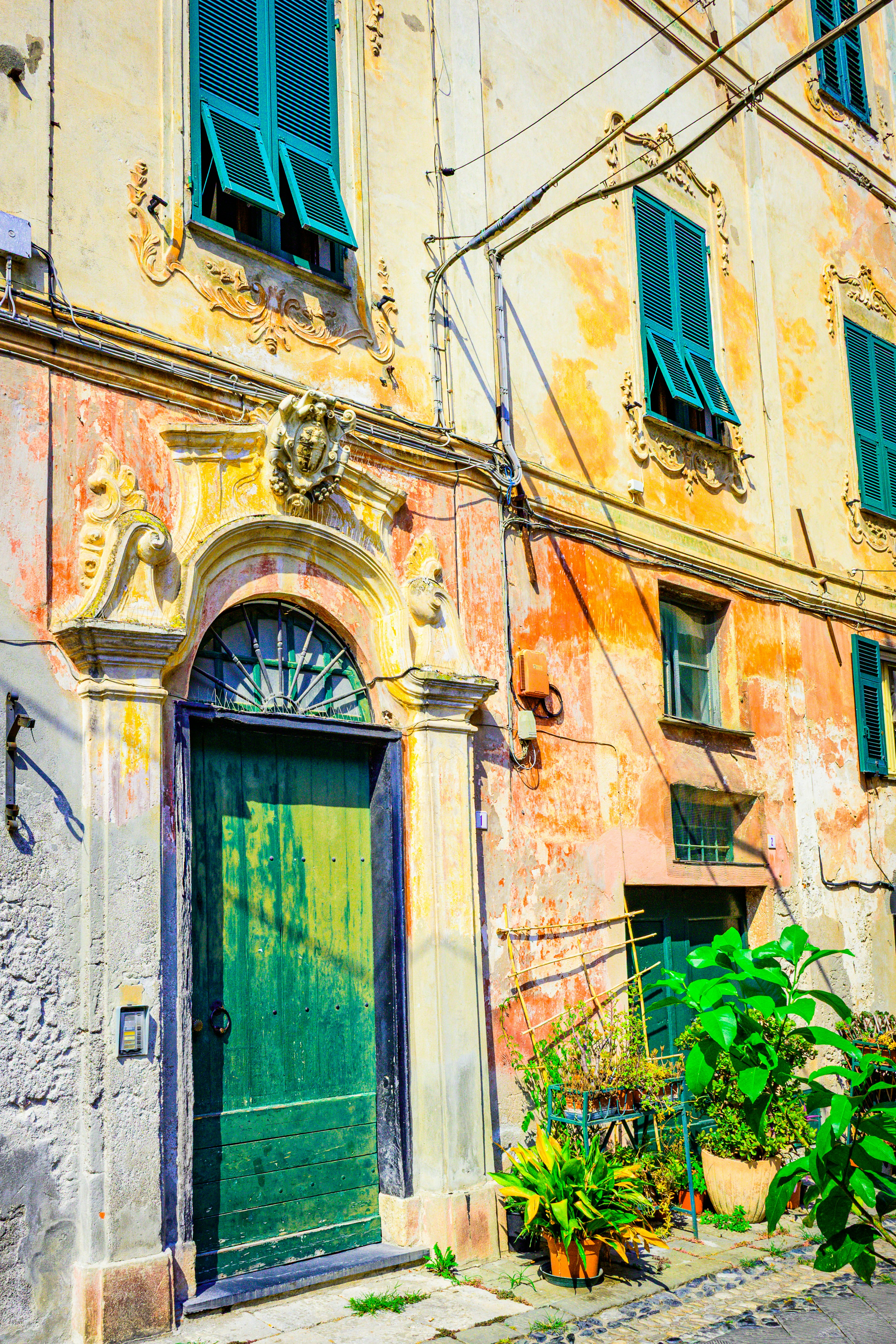 Rust and Color: A Sunlit Facade with Green Doors