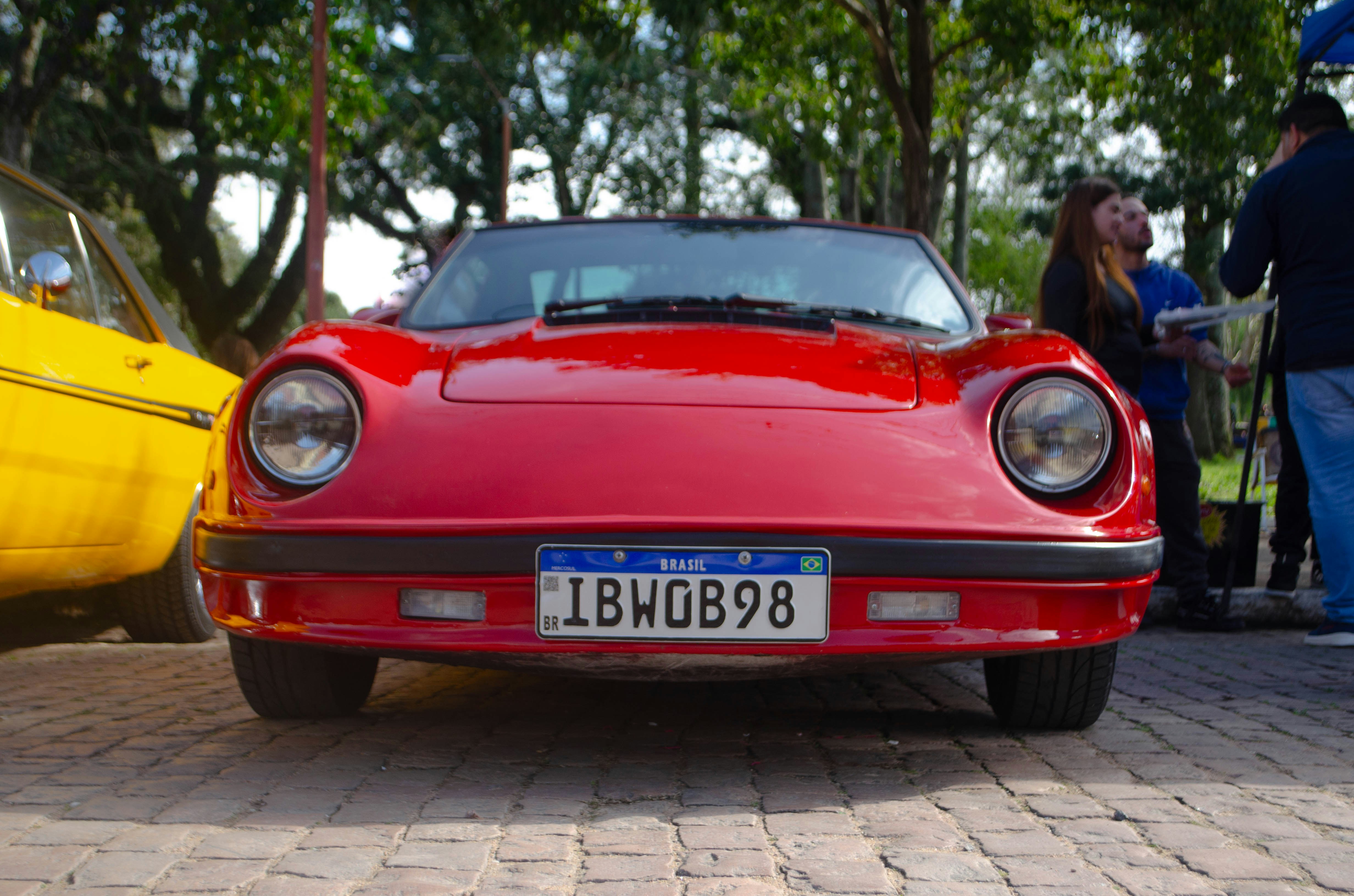 Low-Angle Red: Classic Porsche Gaze Across Cobbled Stage