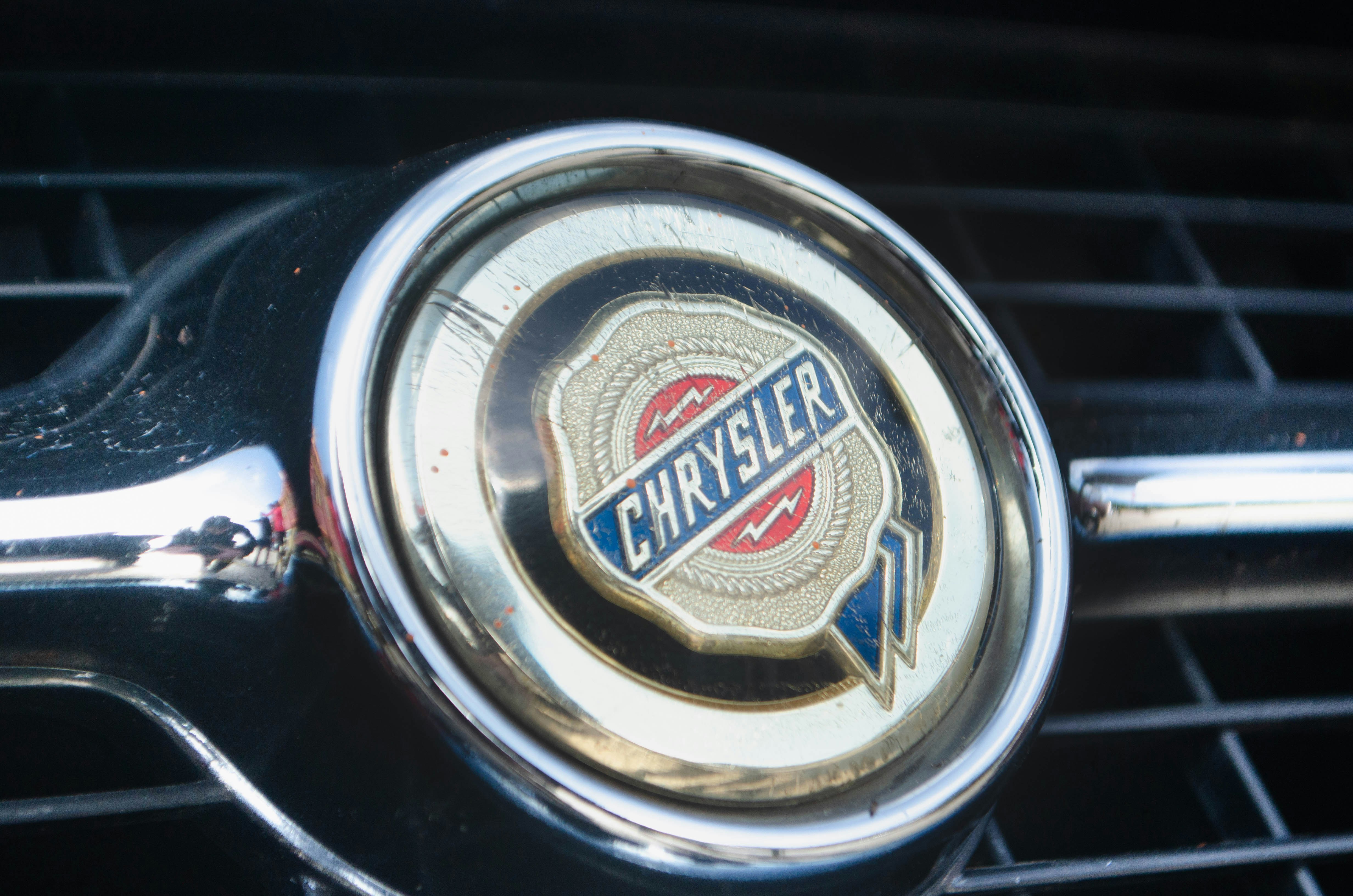 Chrome Emblem Center: Classic Chrysler Badge Framed by Grille Grays