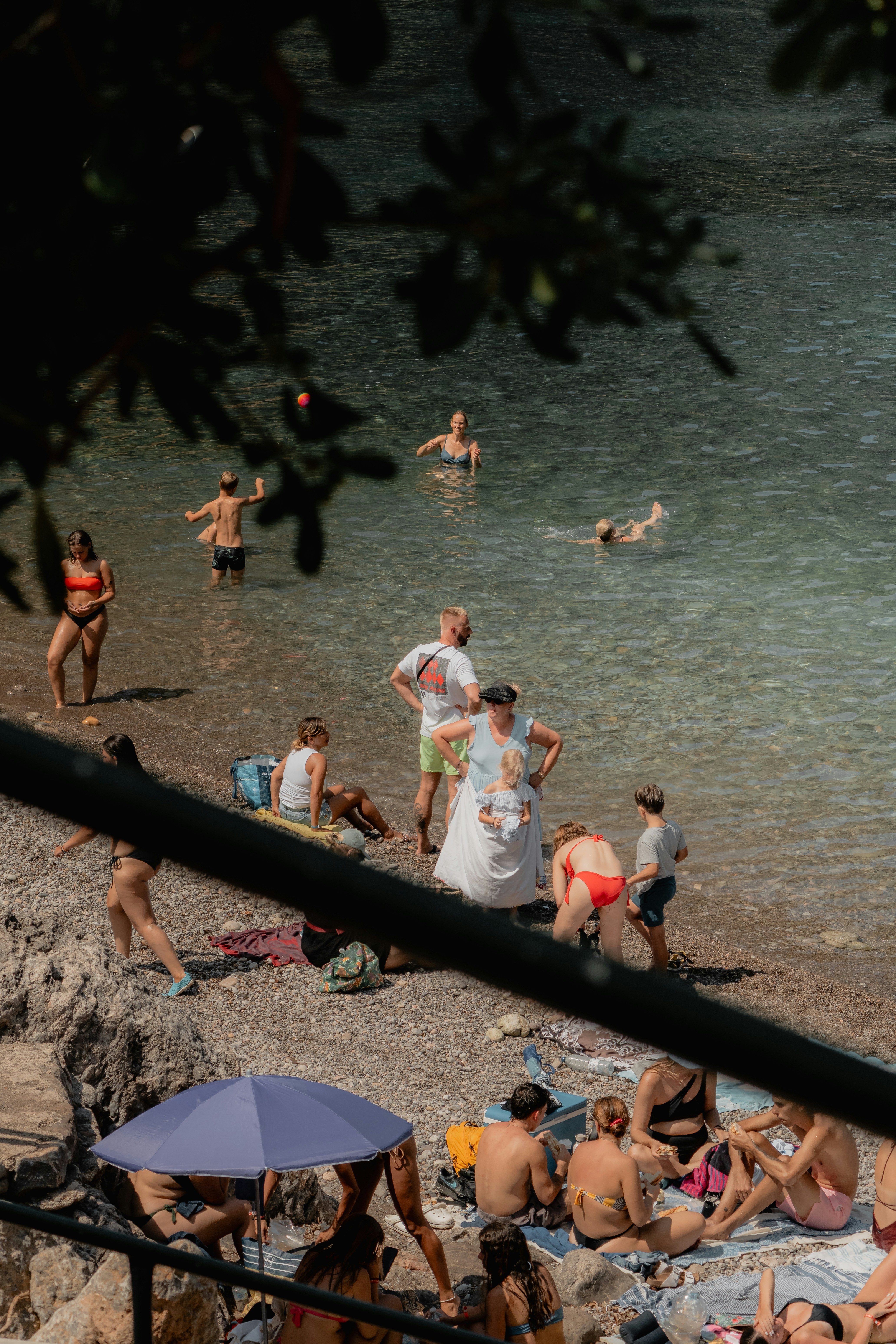 Sun-Kissed Shoreline: A Lively Beach Day Framed by Foreshadowing Shadows