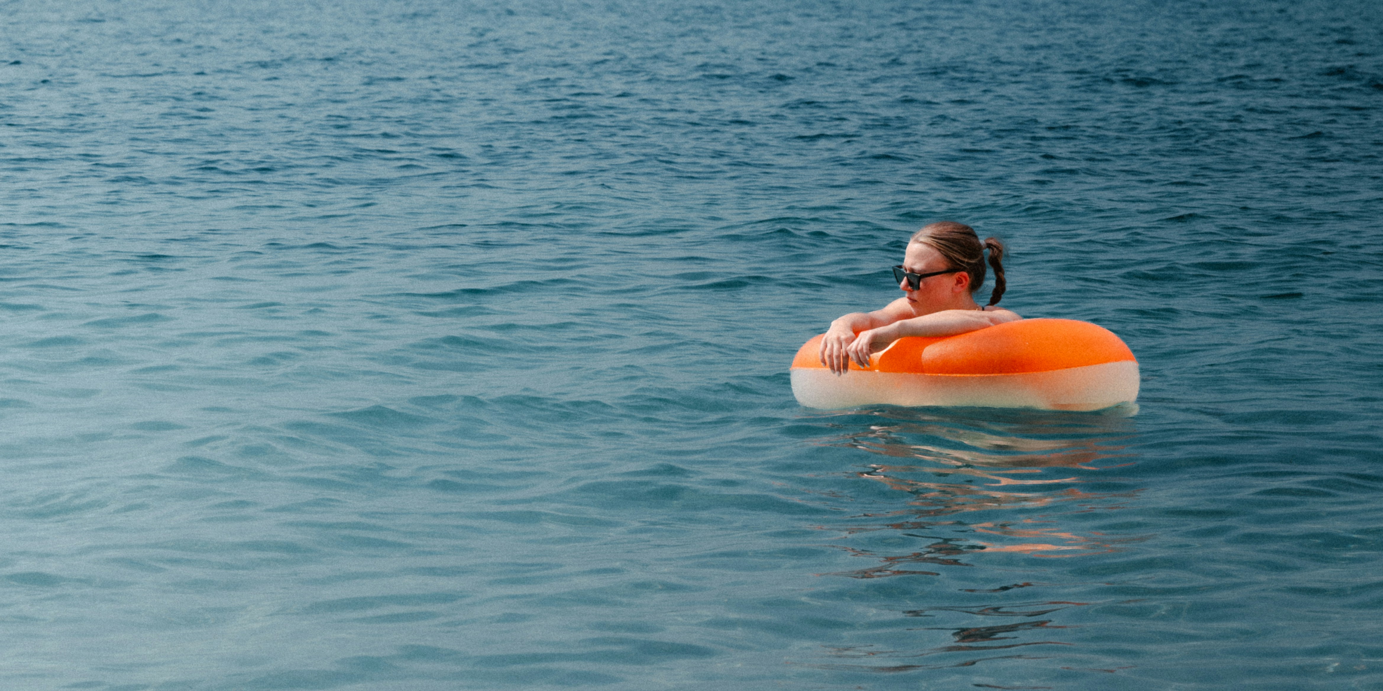 Floating on Calm Blue: A Solo Moment in the Sea