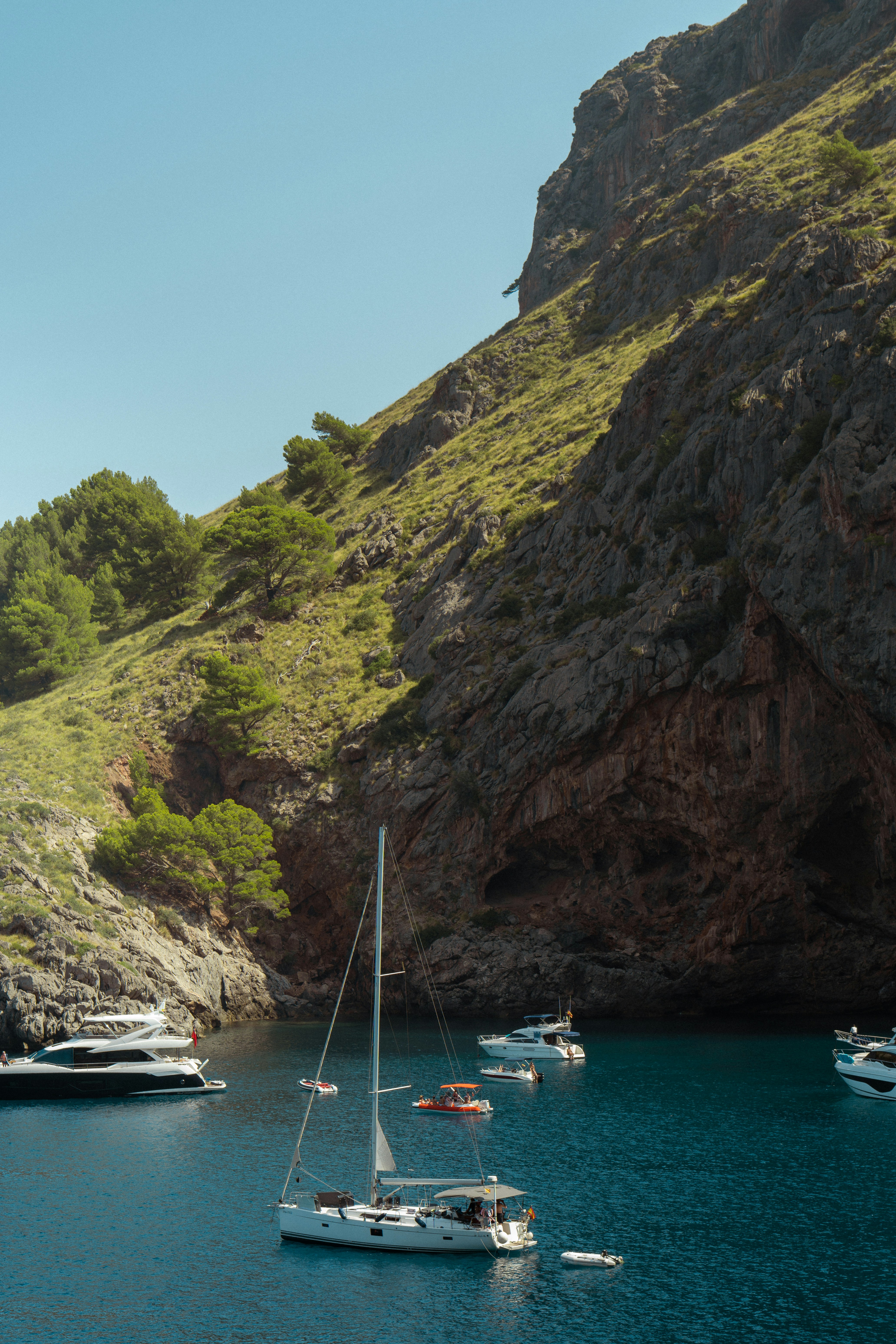 Harbor of Hidden Cliffs: Boats Rest in a Blue Cove