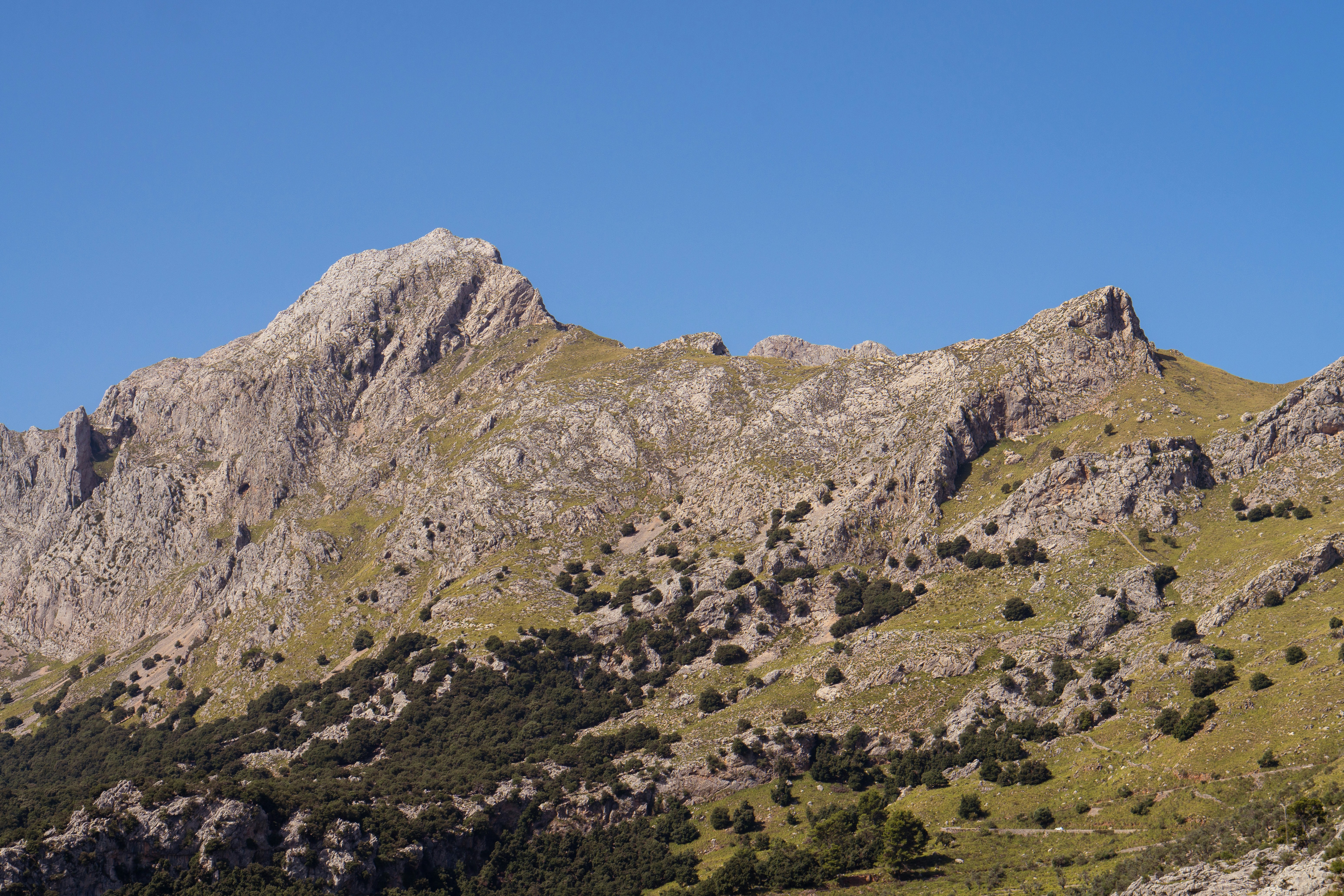 Beneath a Clear Sky: Rugged Peaks over a Shrouded Ridge