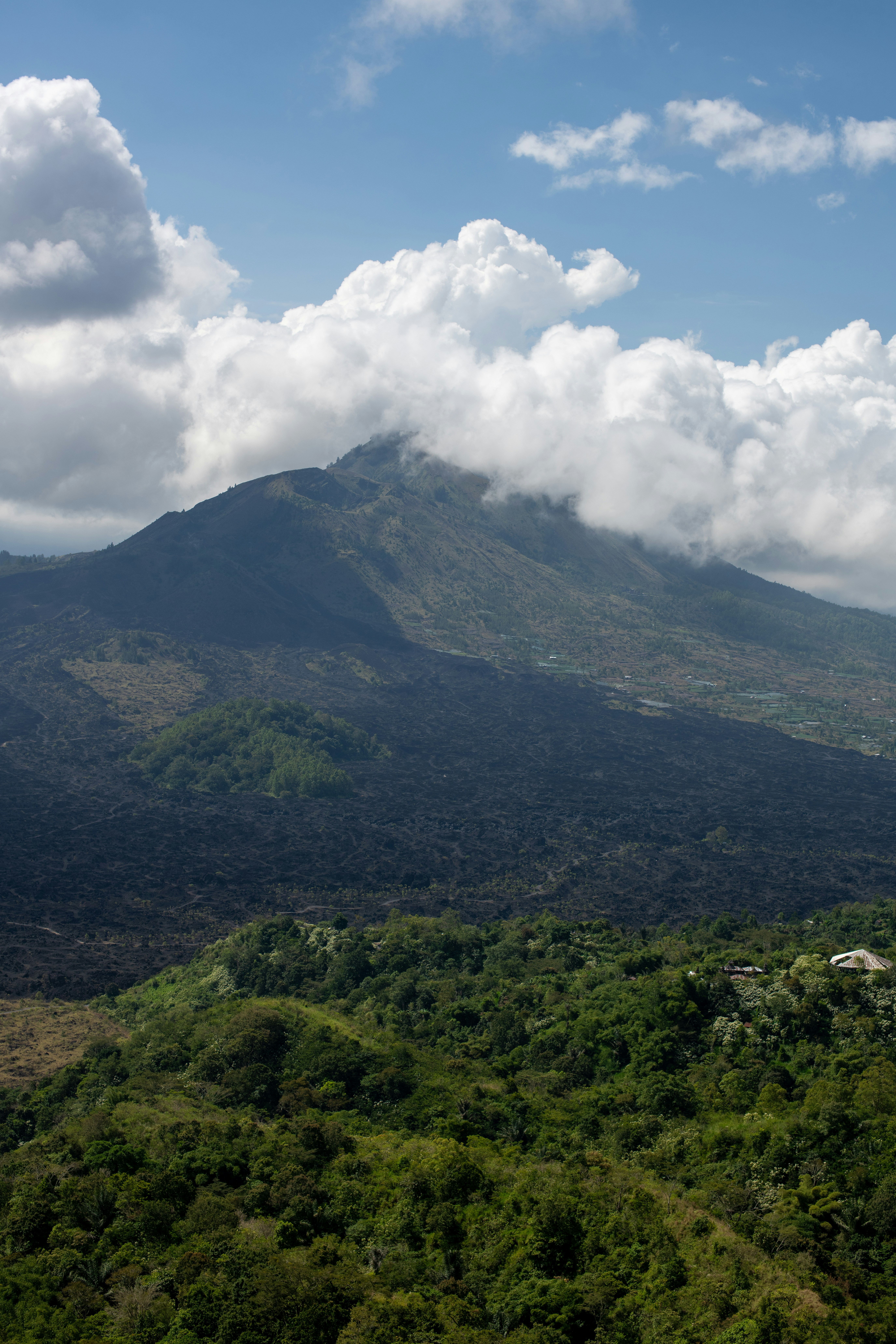 Cloud-veiled Volcanic Summit Above a Lush Green Valley