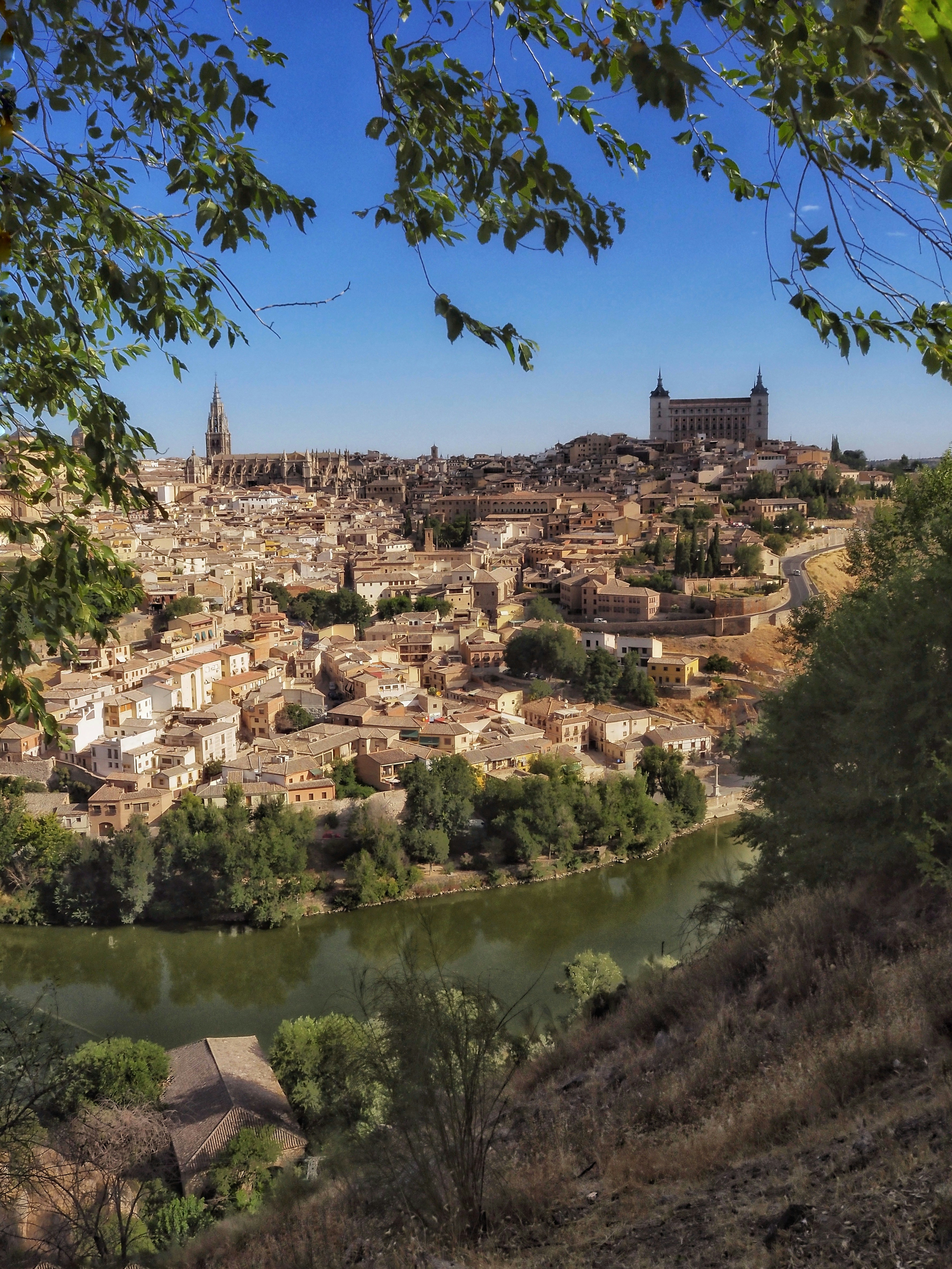Beneath Blue Skies: A Terracotta Town Reaching Toward the River