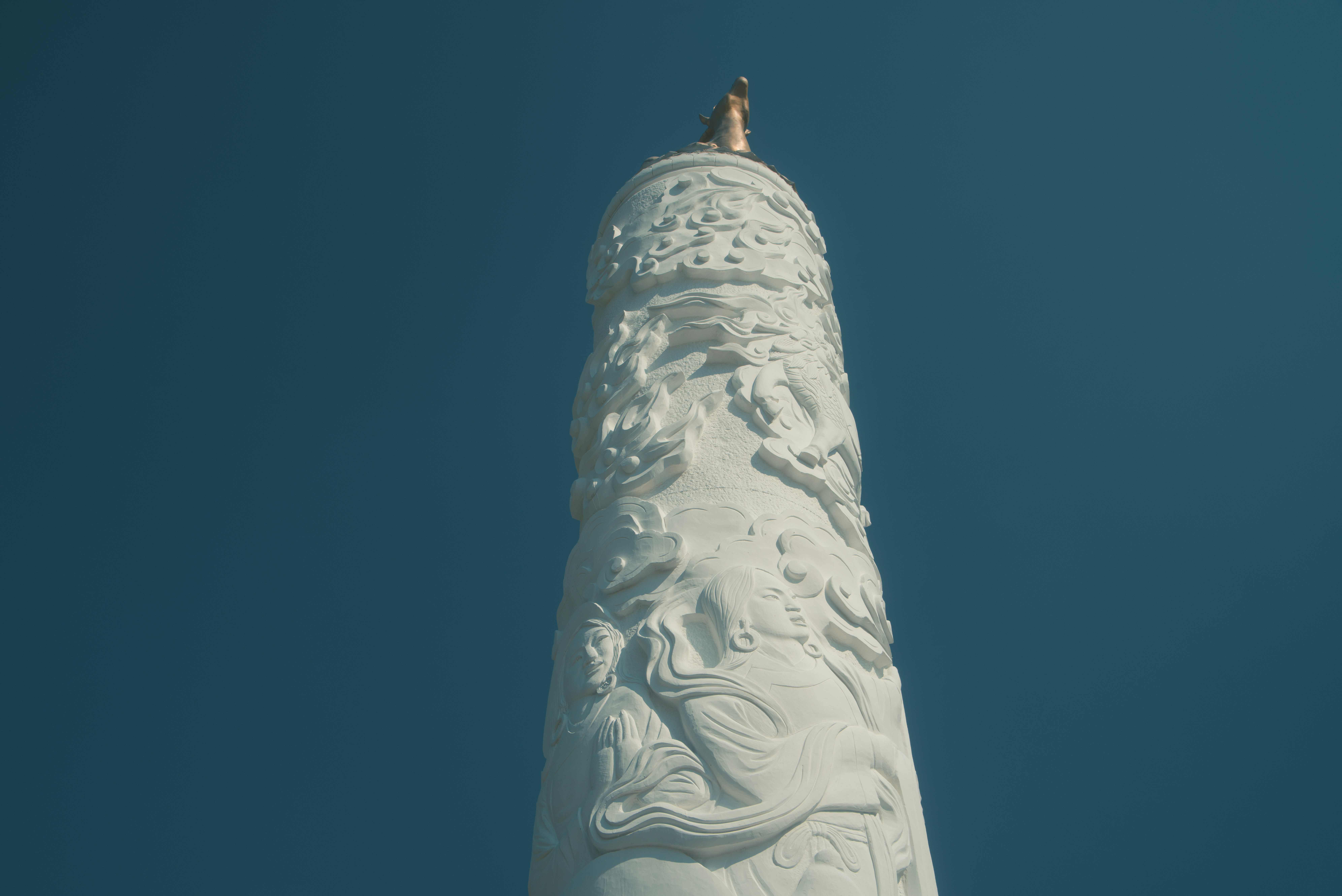 Carved Skyward Shrine: A Snow-White Obelisk Reaching the Blue