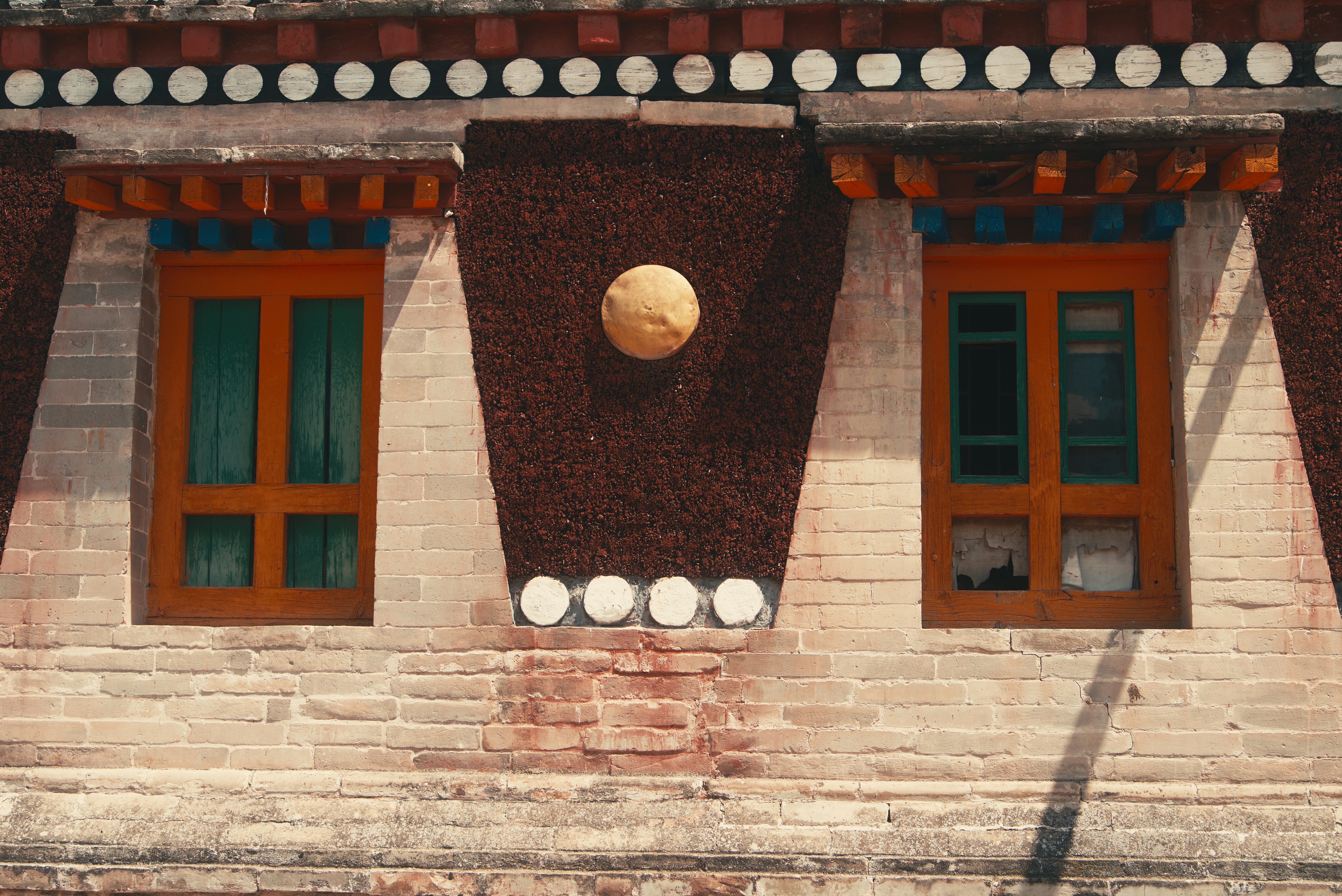 Sunlit Temple Window Row with Circular Ornament