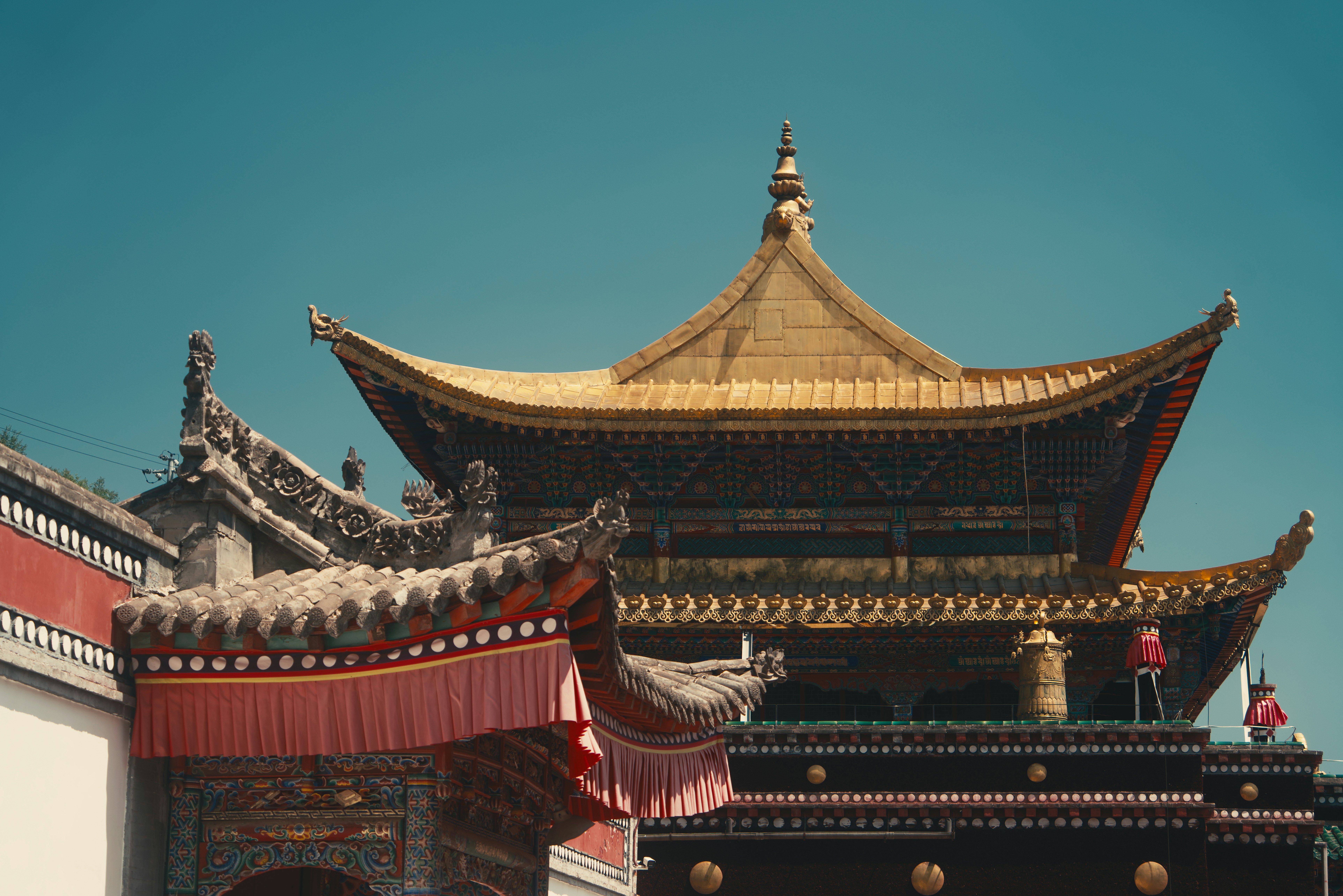 Golden Roofline: A Stone-and-Tk Temple Crowned in Evening Light