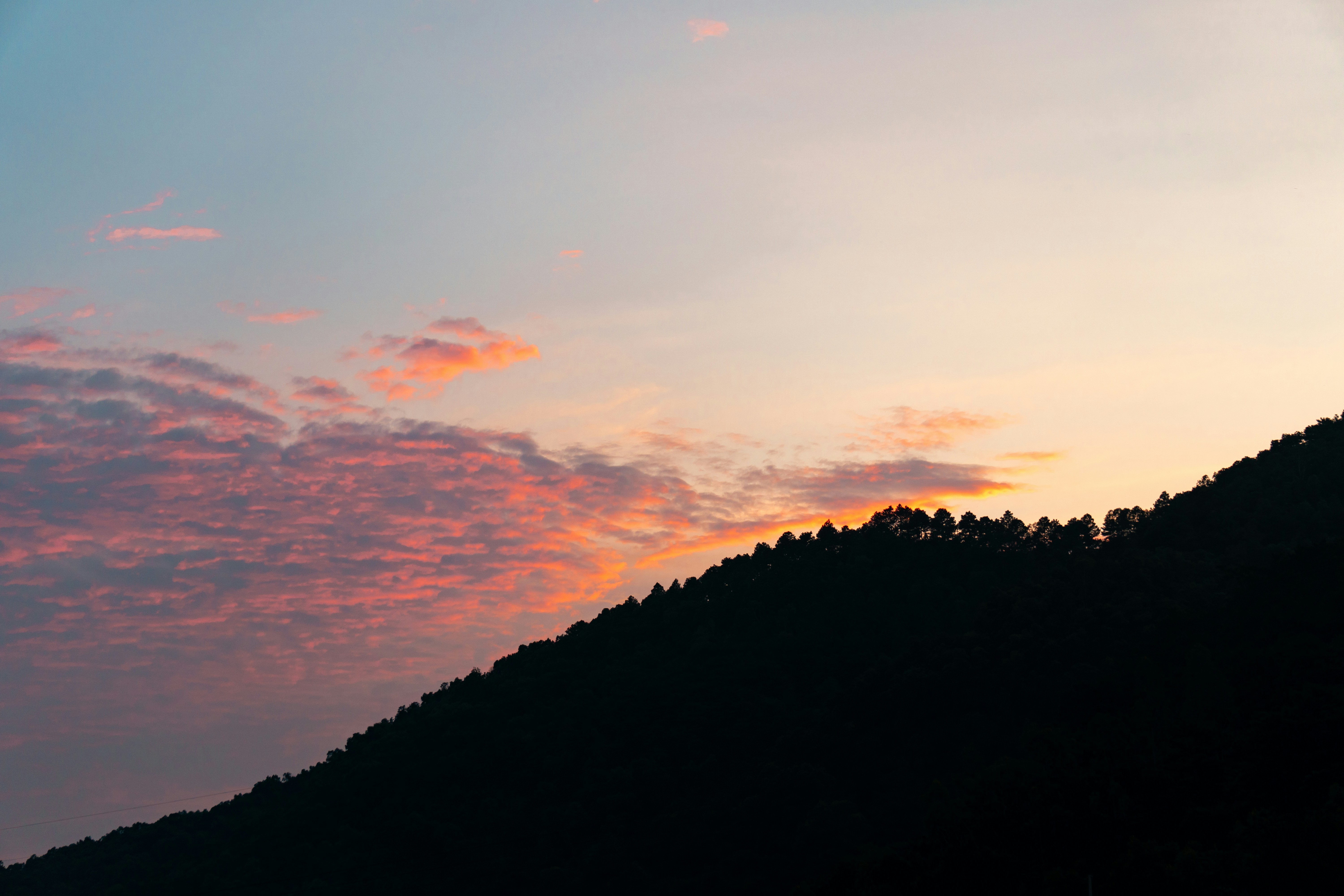 Dusk over the Silhouette: A Quiet Hilltop Sunset
