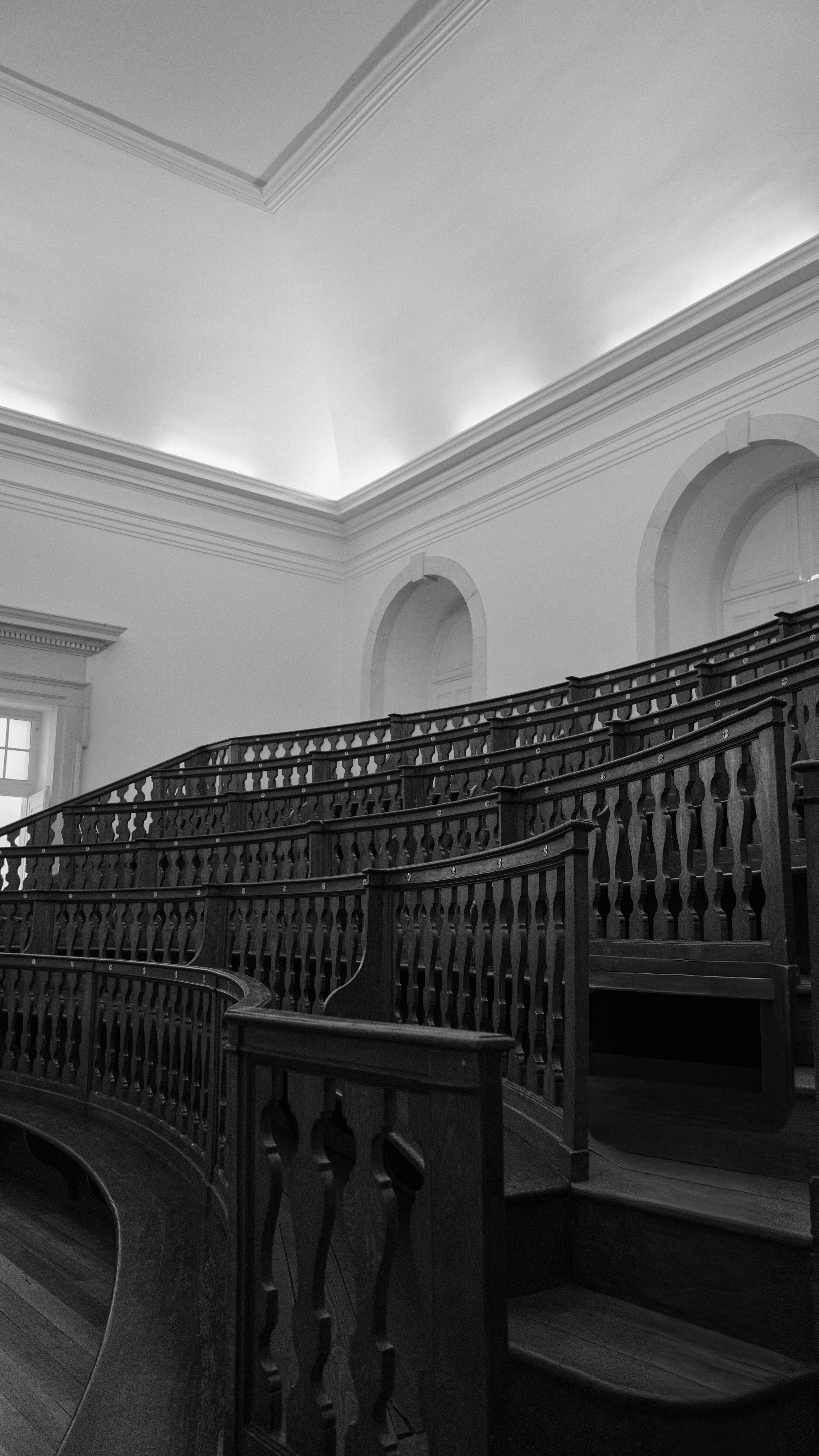 Wooden Ranks in Quiet Light: An Old Lecture Hall's Curve