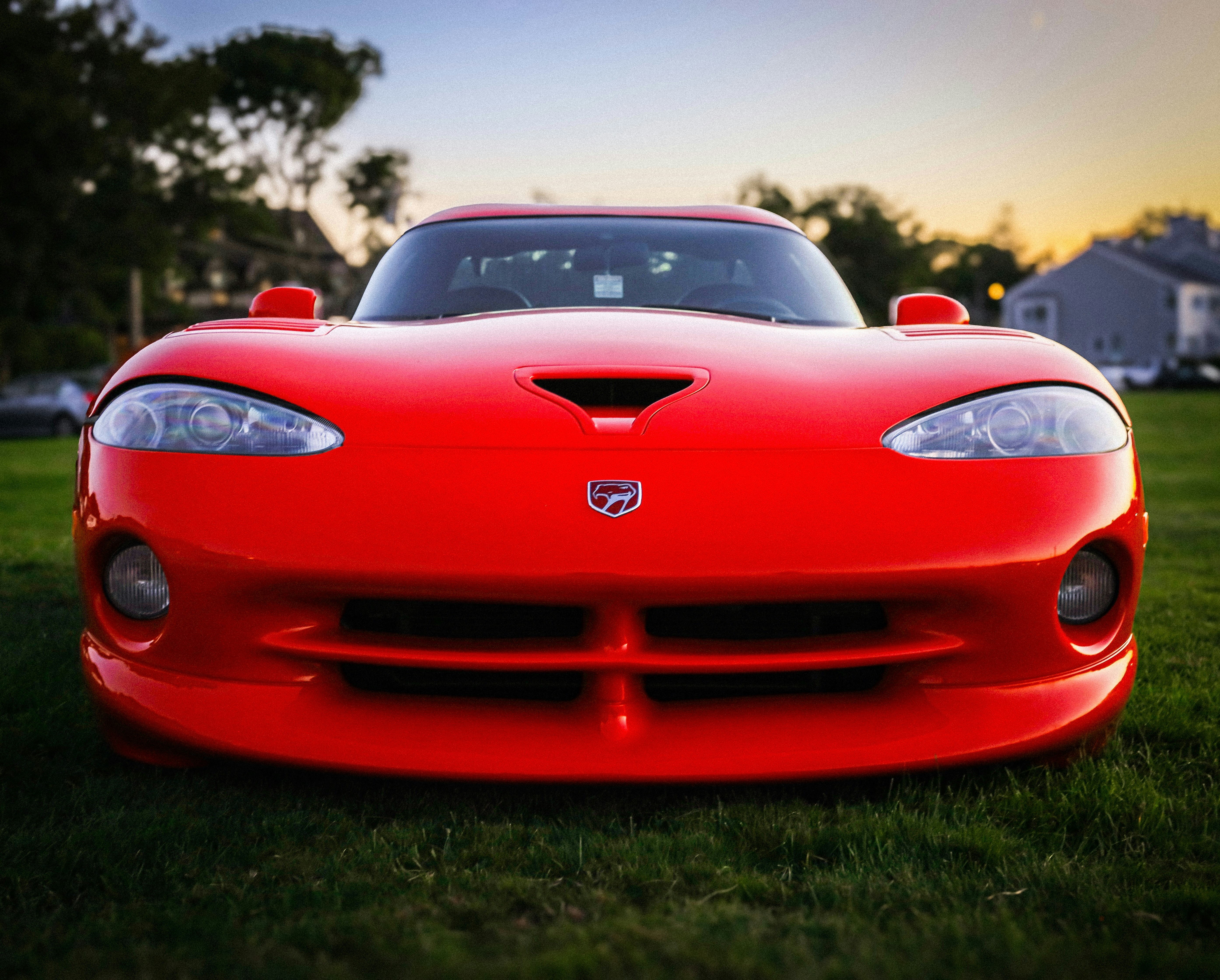 Red Chrome: Front View of a Sleek Sports Car in Golden Hour