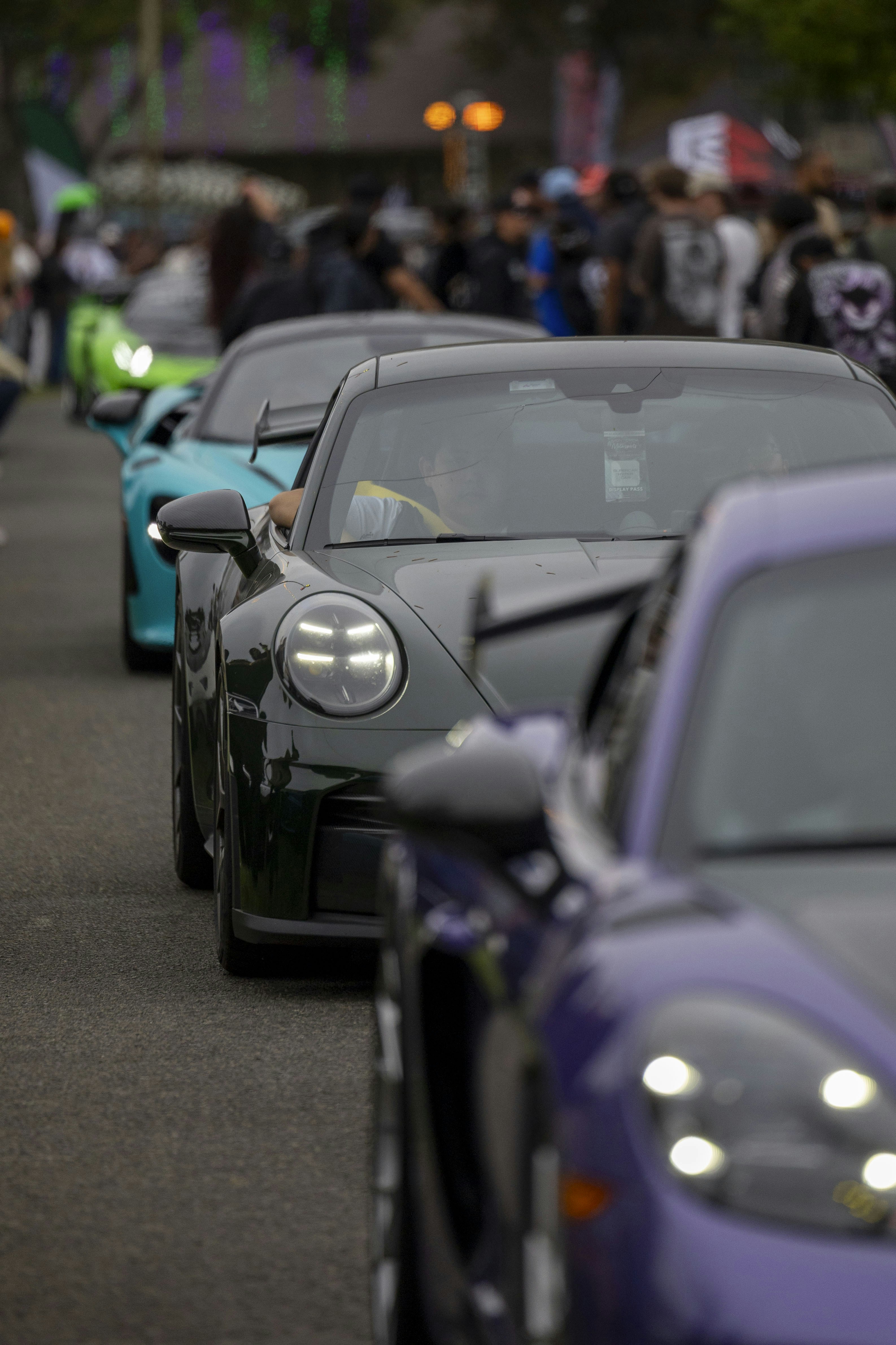 Line of Velocity: A Row of Porsche Rims and Show Cars