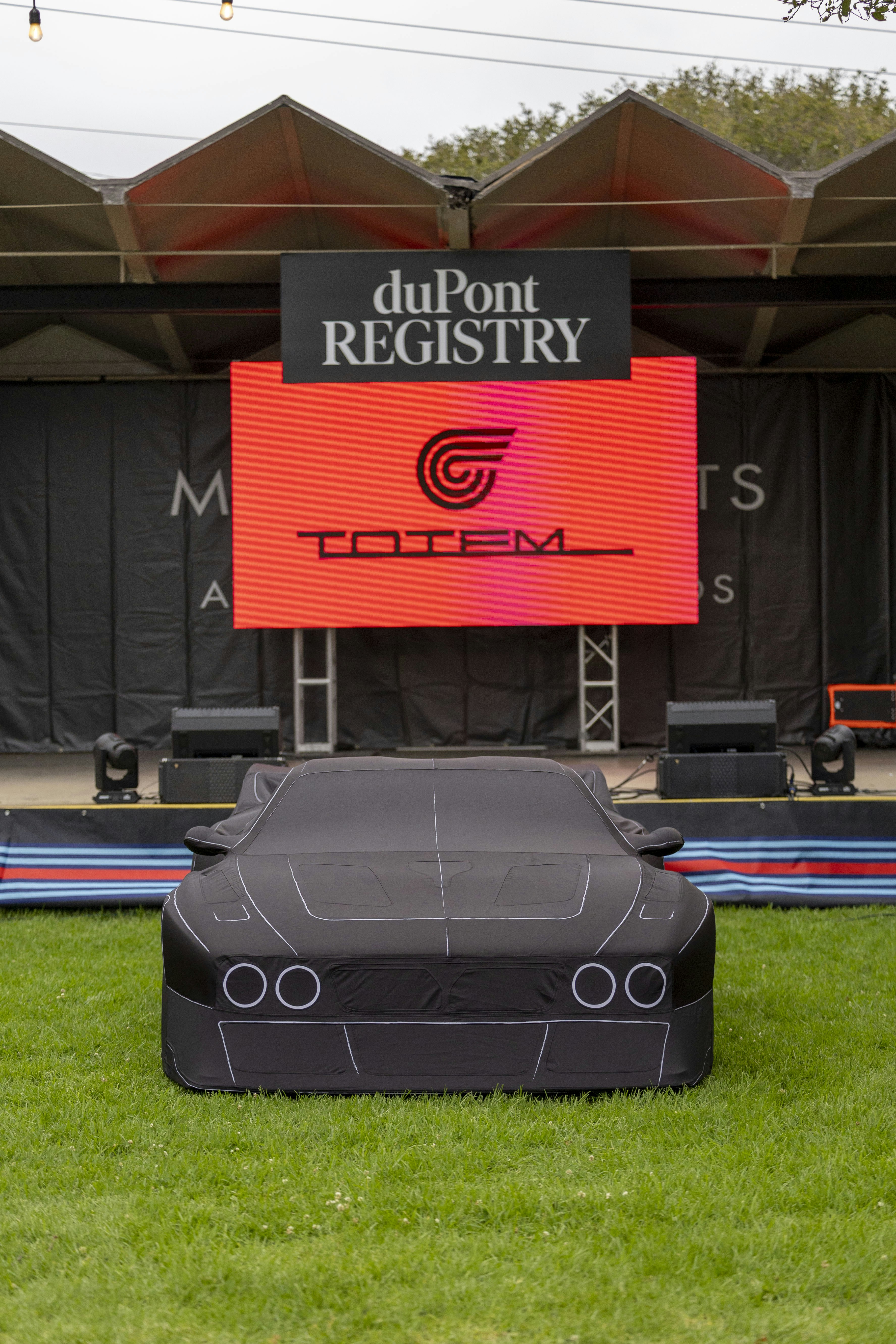 Hidden Elite: The Matte Mystery of the Draped Supercar at Center Stage