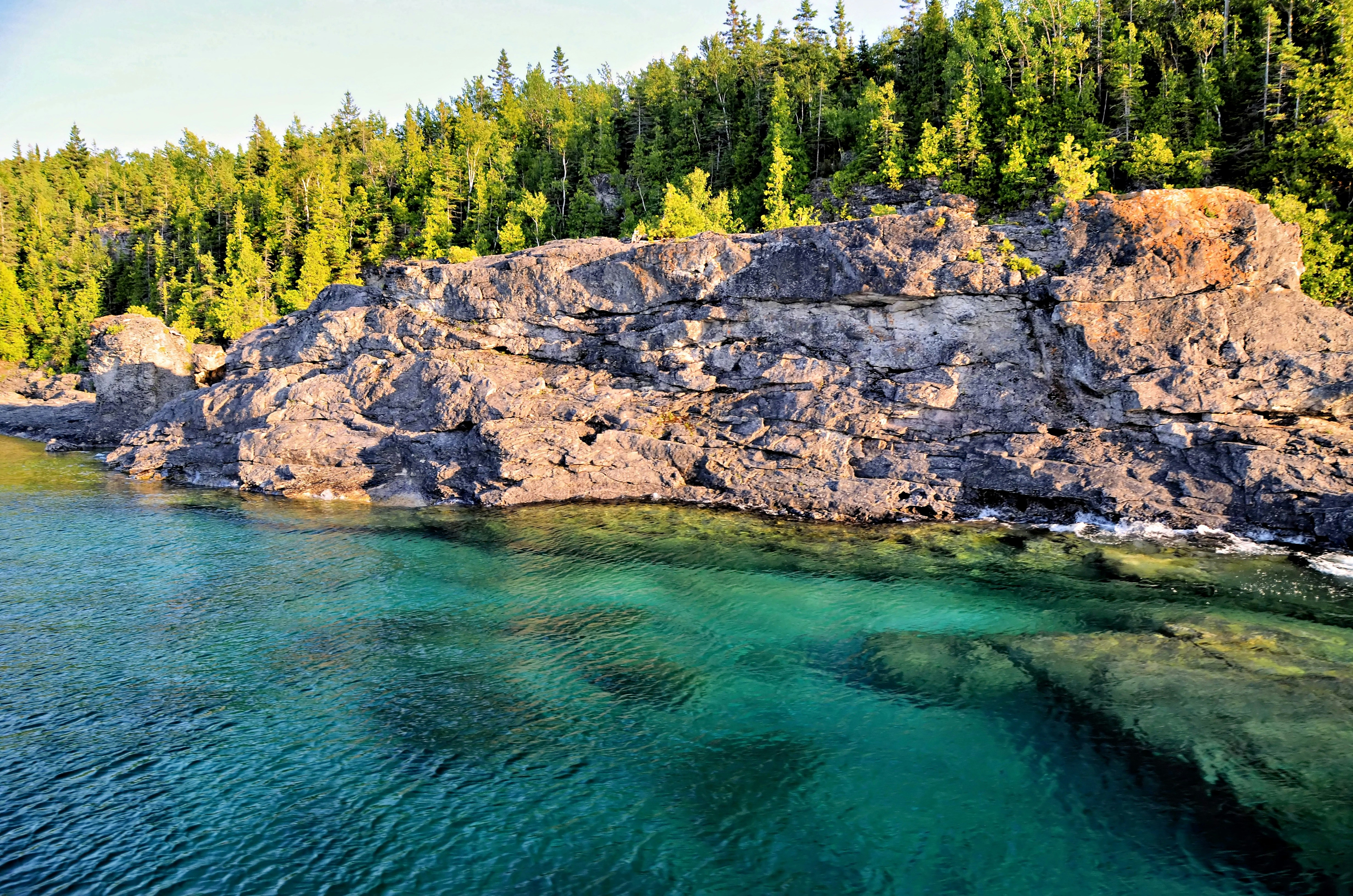 Emerald Inlet Cliff: turquoise waters meet rugged shoreline