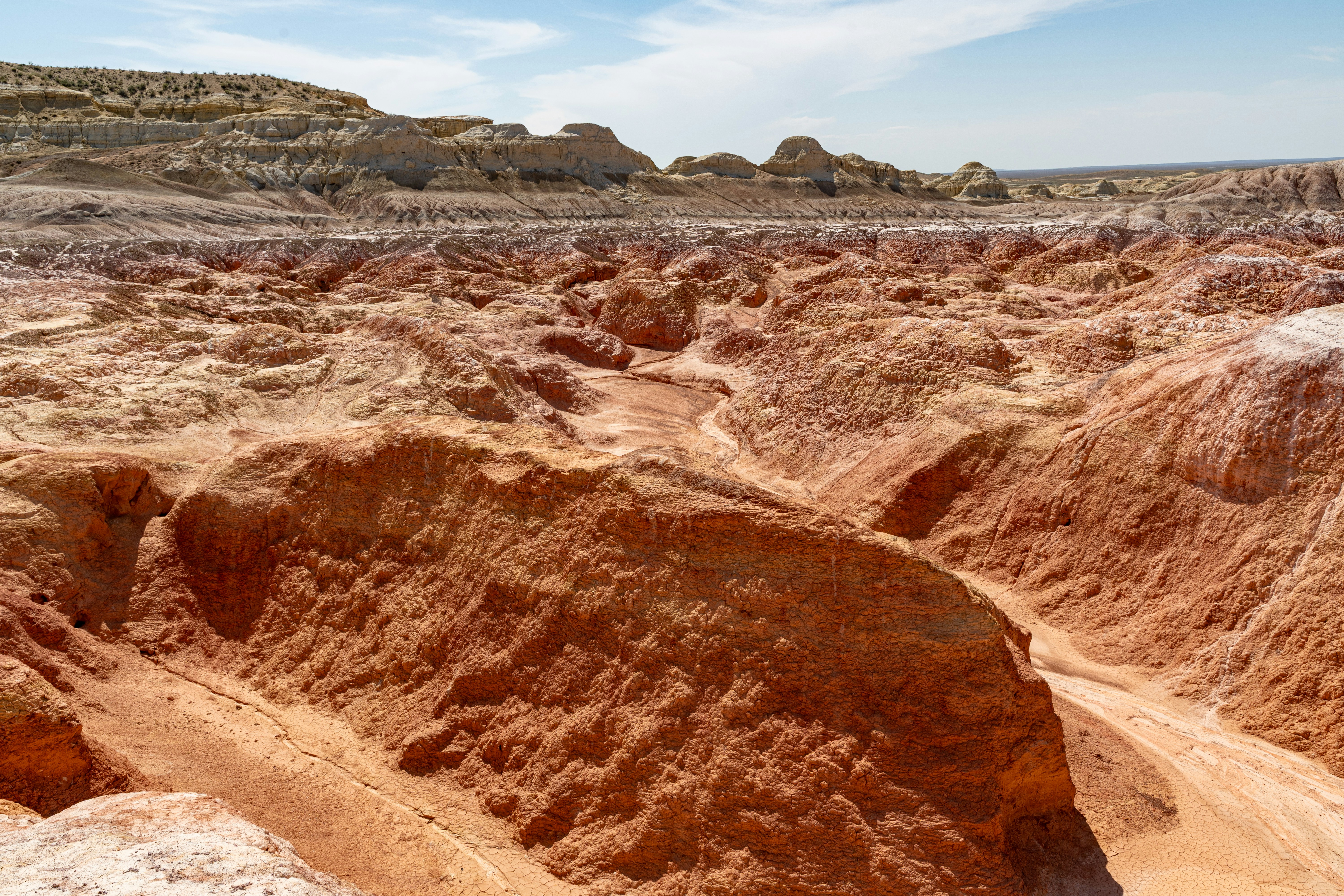 Crimson Tides: Eroded Badlands Under a Clear Horizon
