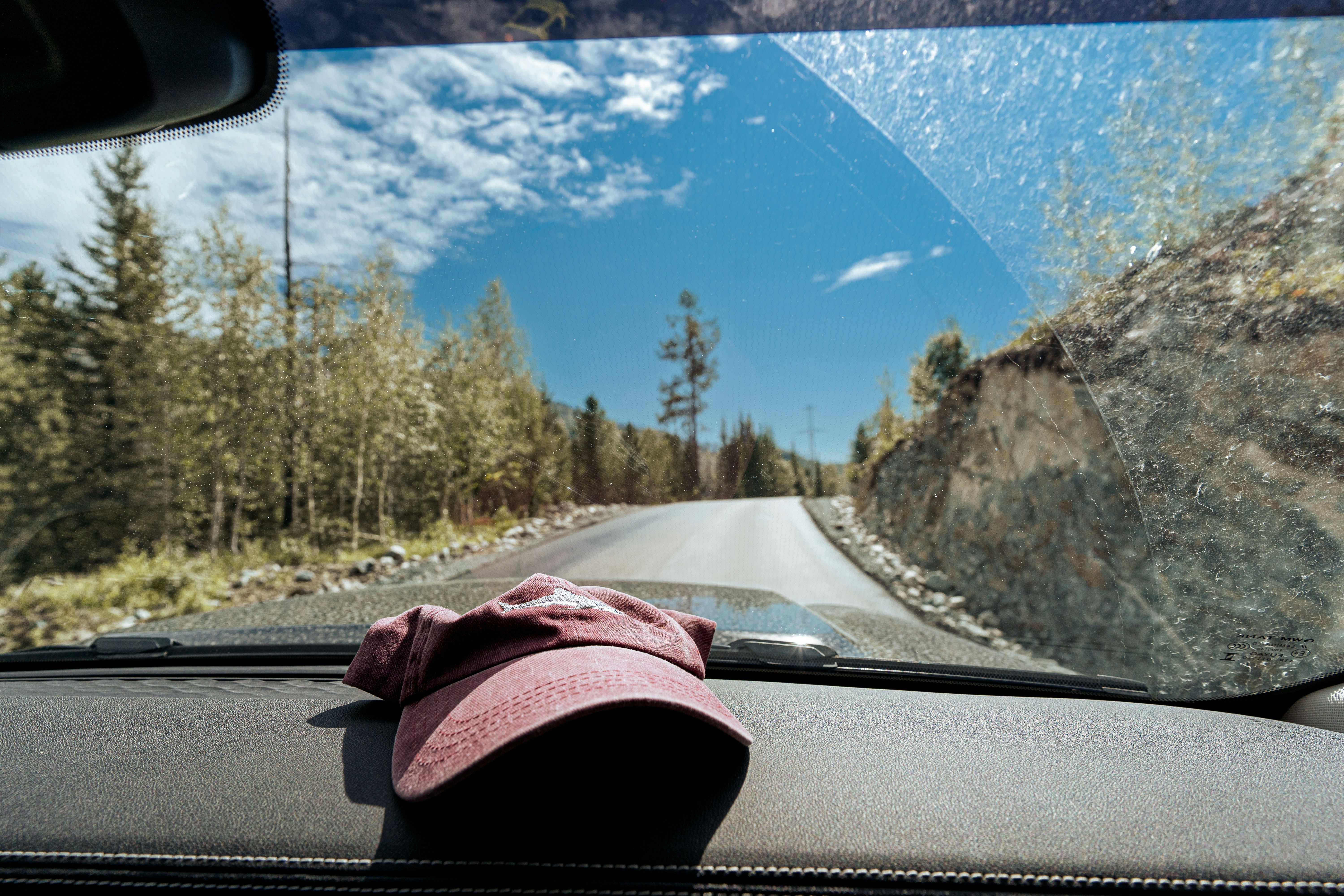 Front-Row View Through the Windshield: Road Ahead with Cap in the Cabin
