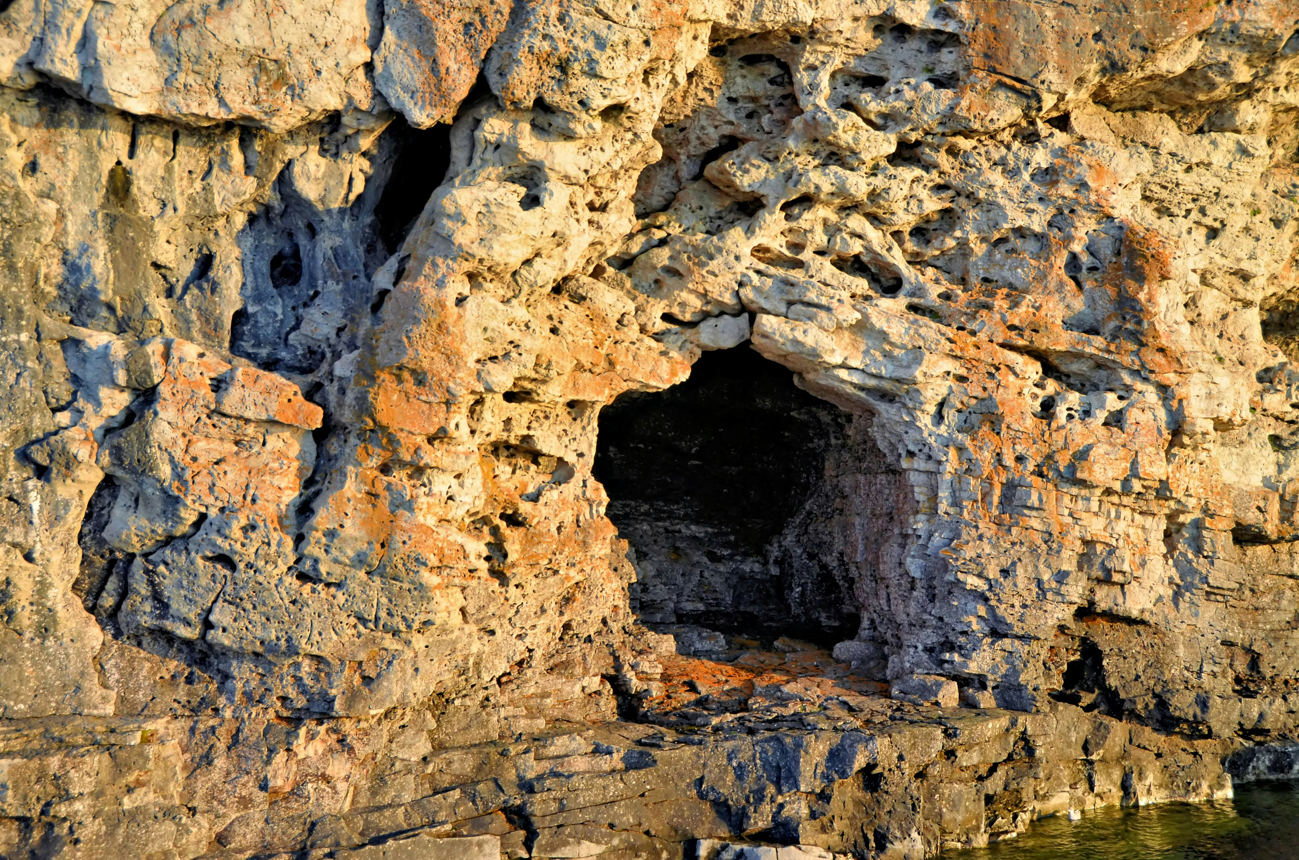 Coastal Cavern Gate: A Weathered Cliff Face Framing a Dark Hollow