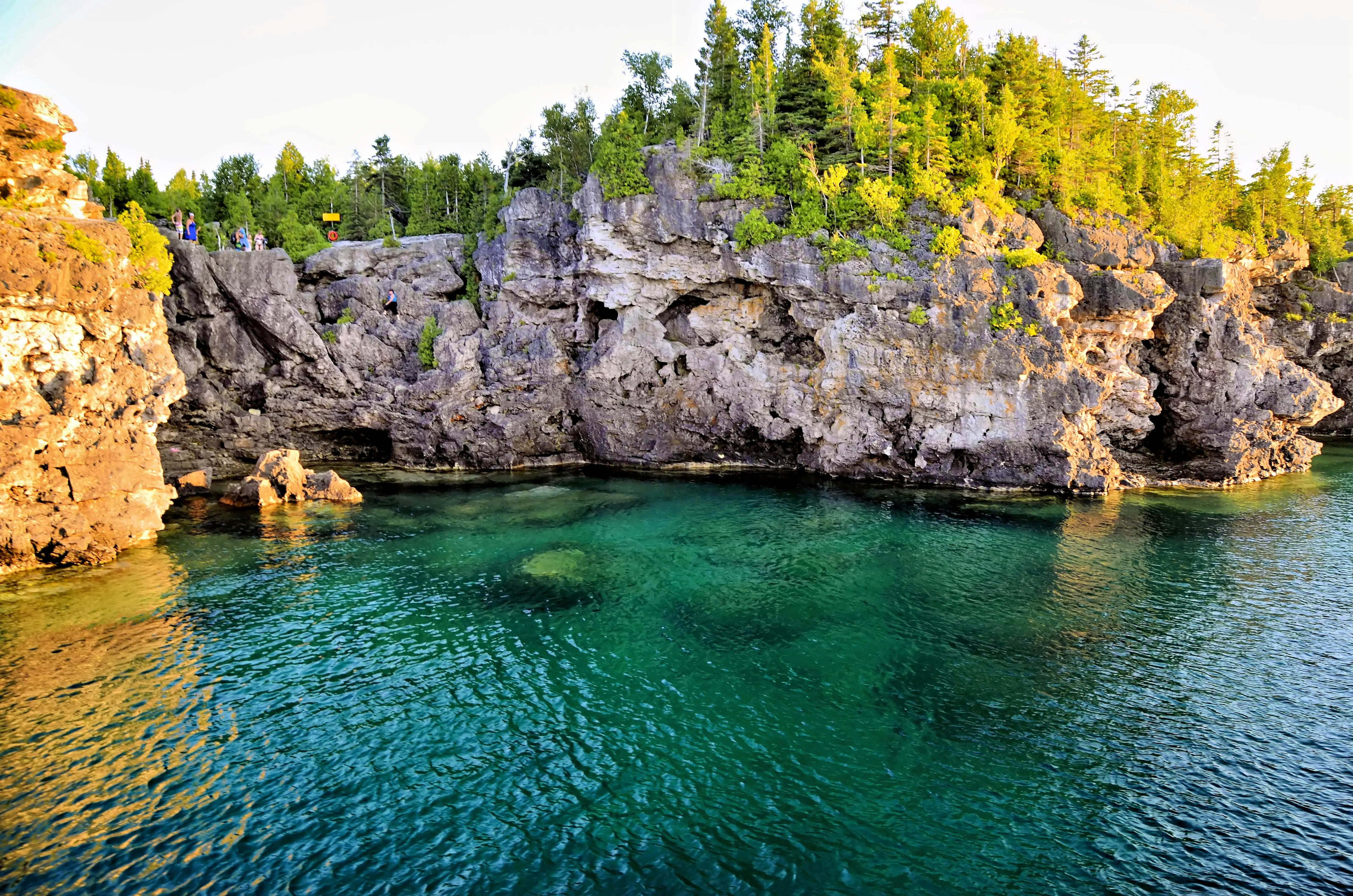 Emerald Waters Meet Weathered Cliffs: A Coastal Window