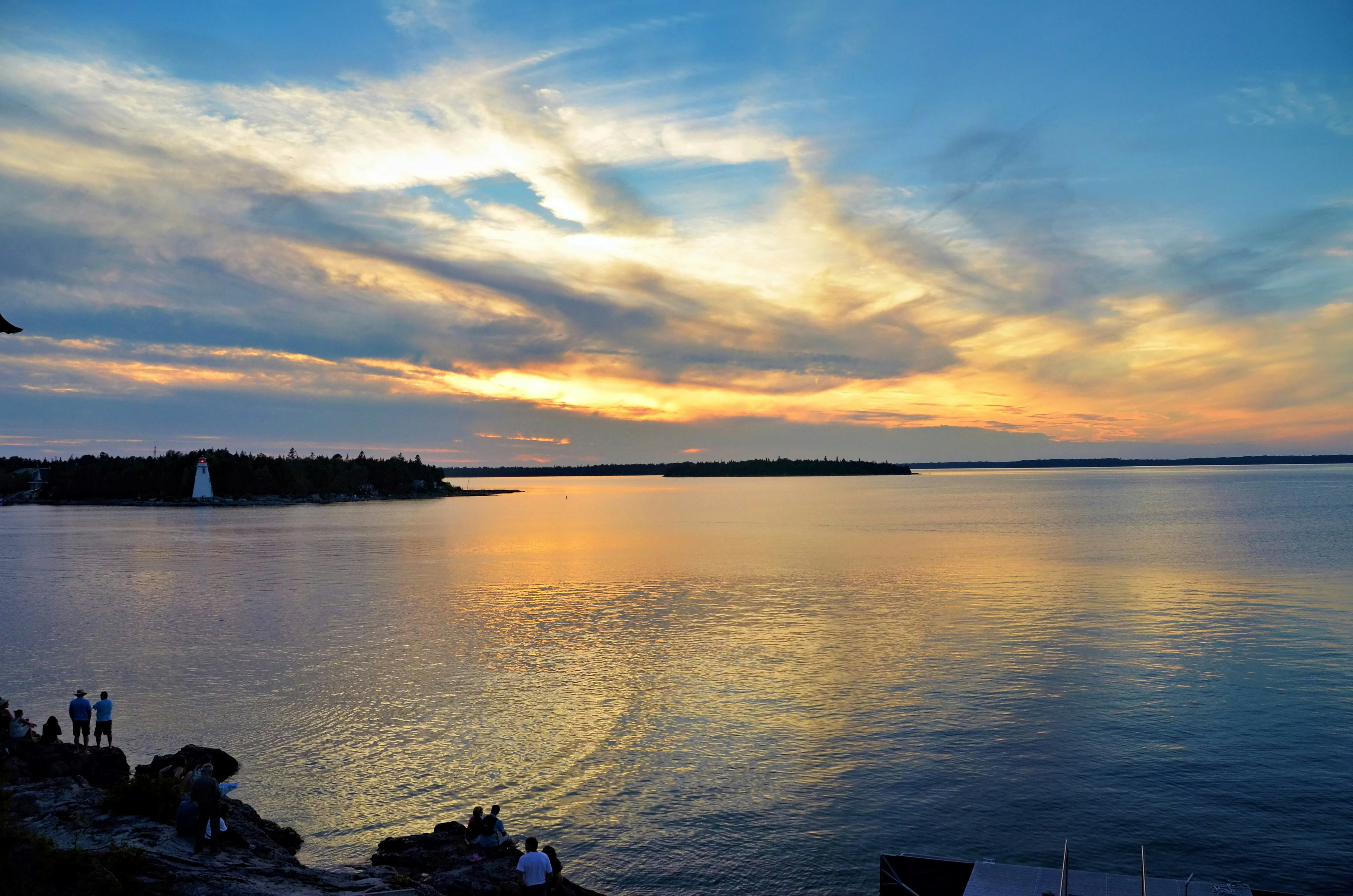 Toward the Orange Horizon: Sunset Over a Quiet Lake