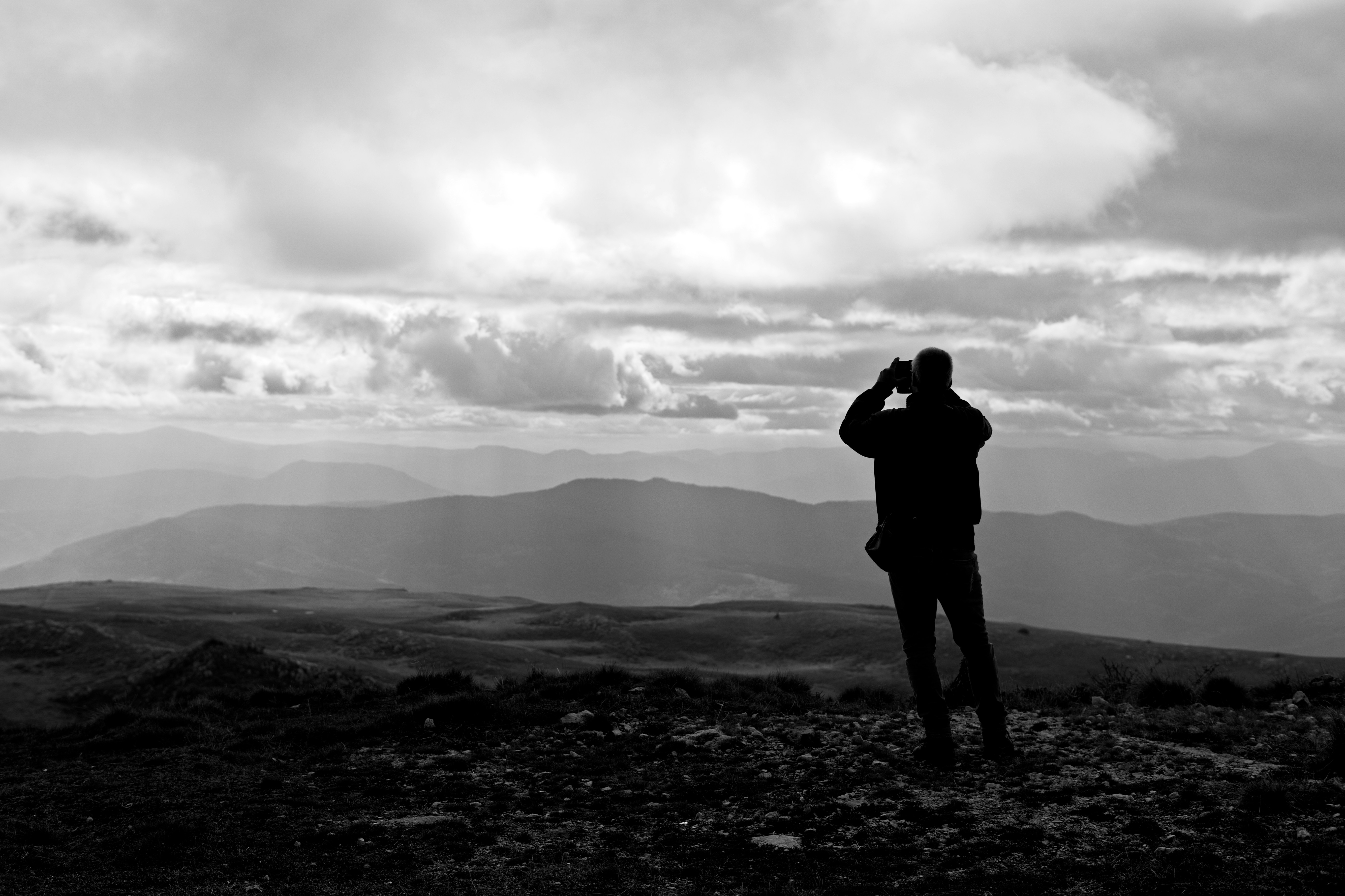 Silhouette of a Traveler against Distant Ridges at Dusk