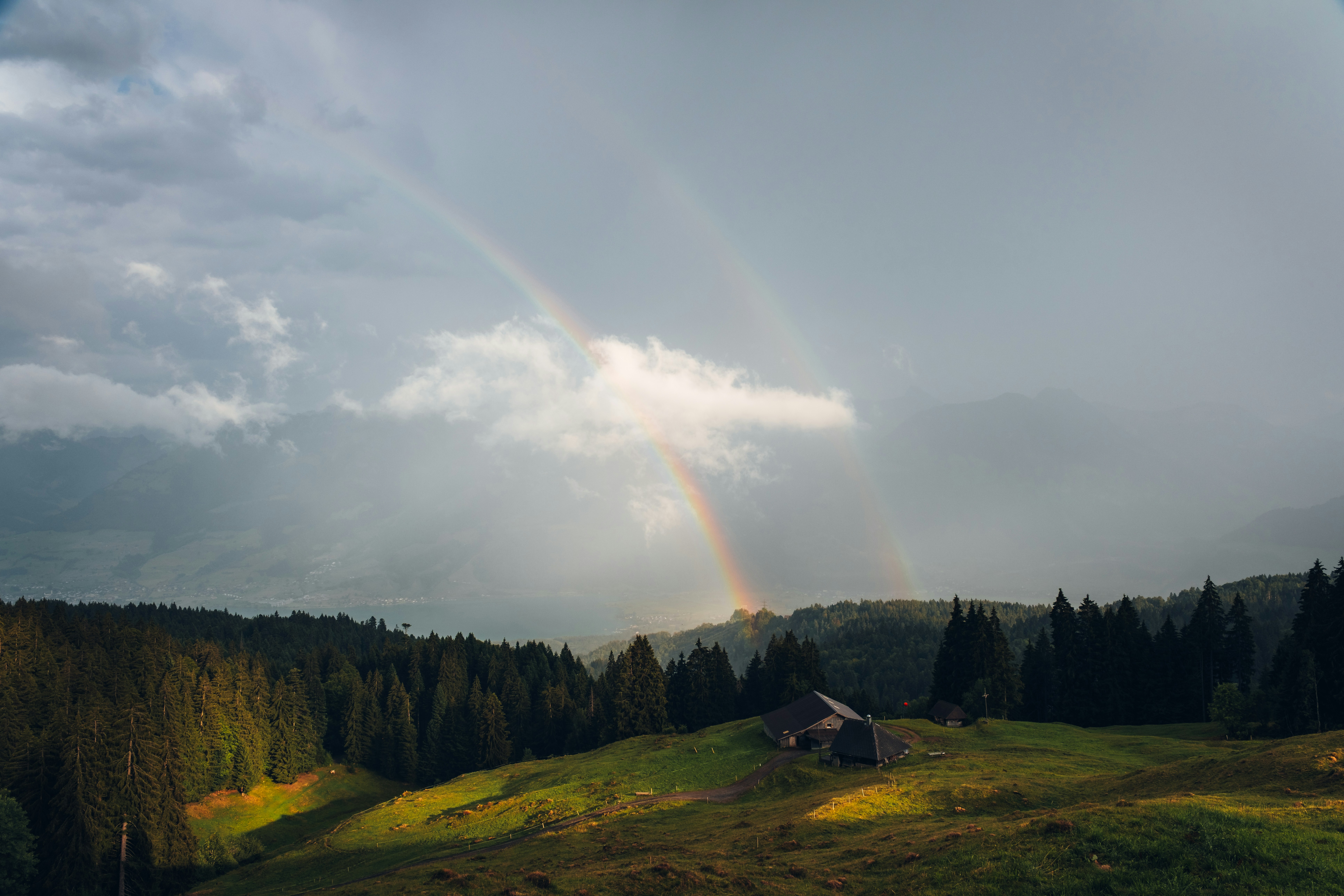 Double Rainbow Over a Quiet Hilltop Cabin