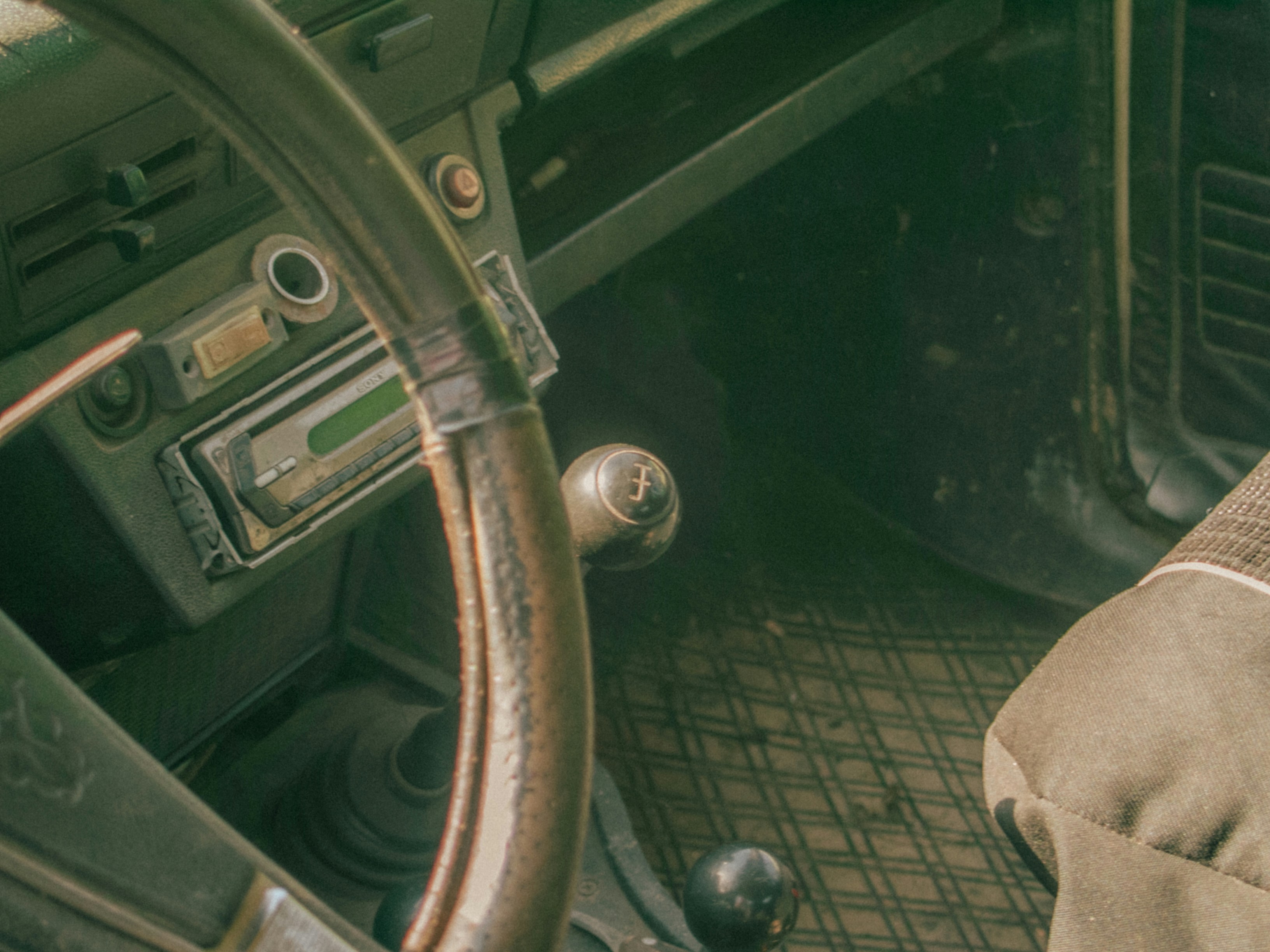 Steering Wheel and Pedal Echoes: Vintage Car Cabin Close-Up
