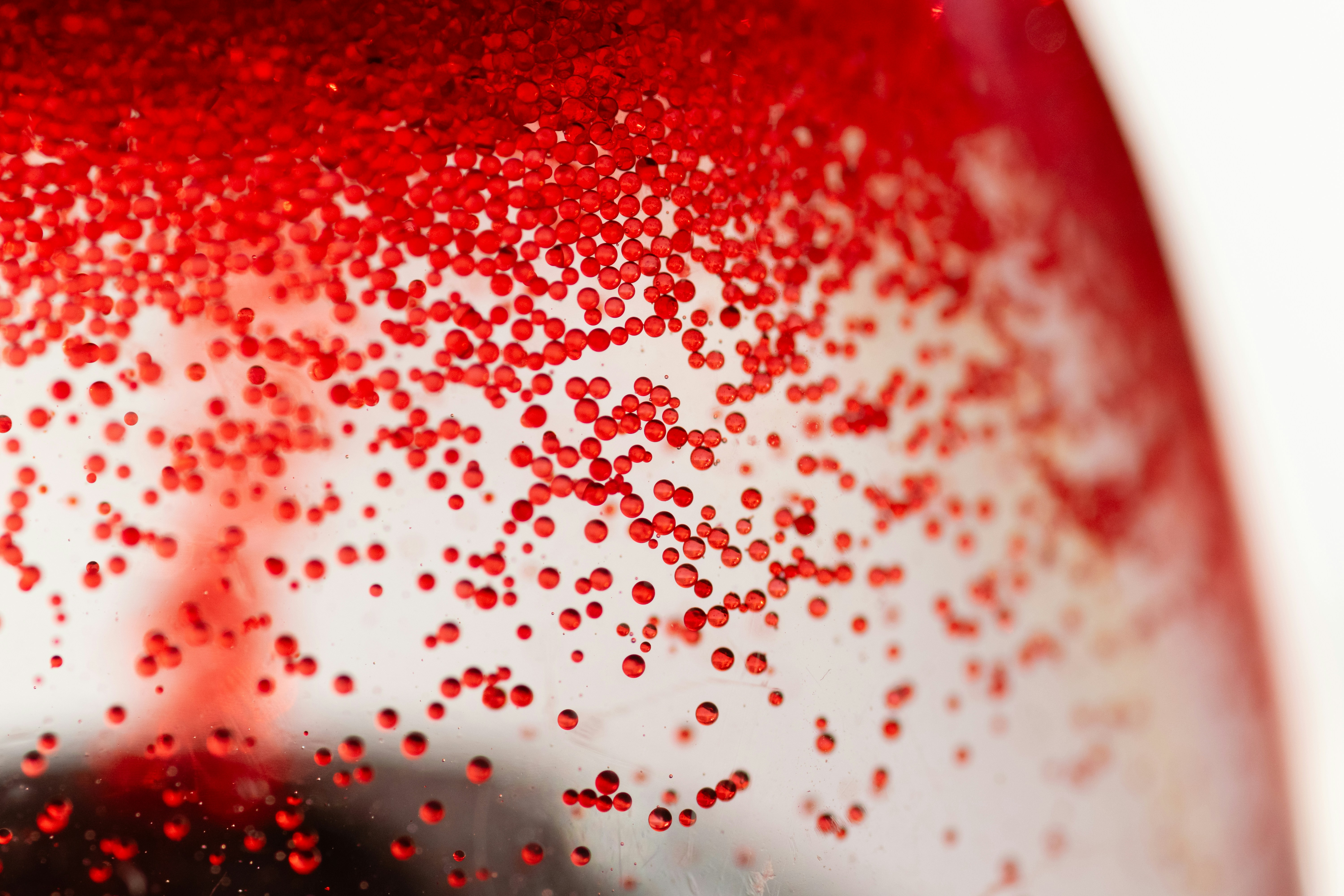 Red Bubbles in a Glass: Close-Up of Fizzy Clarity