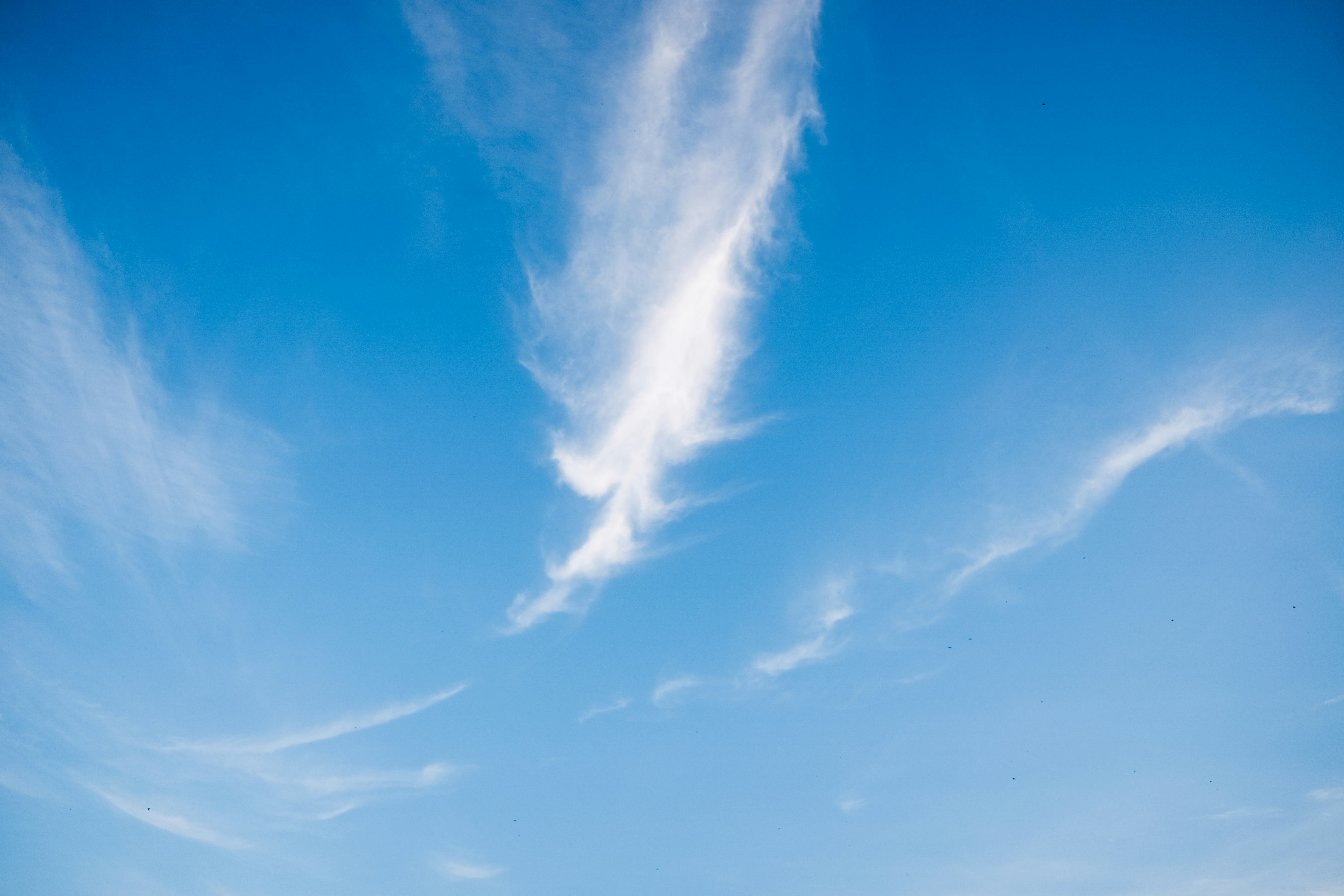 Azure Sky Silk: A Luminous Wake of Cloud Trails