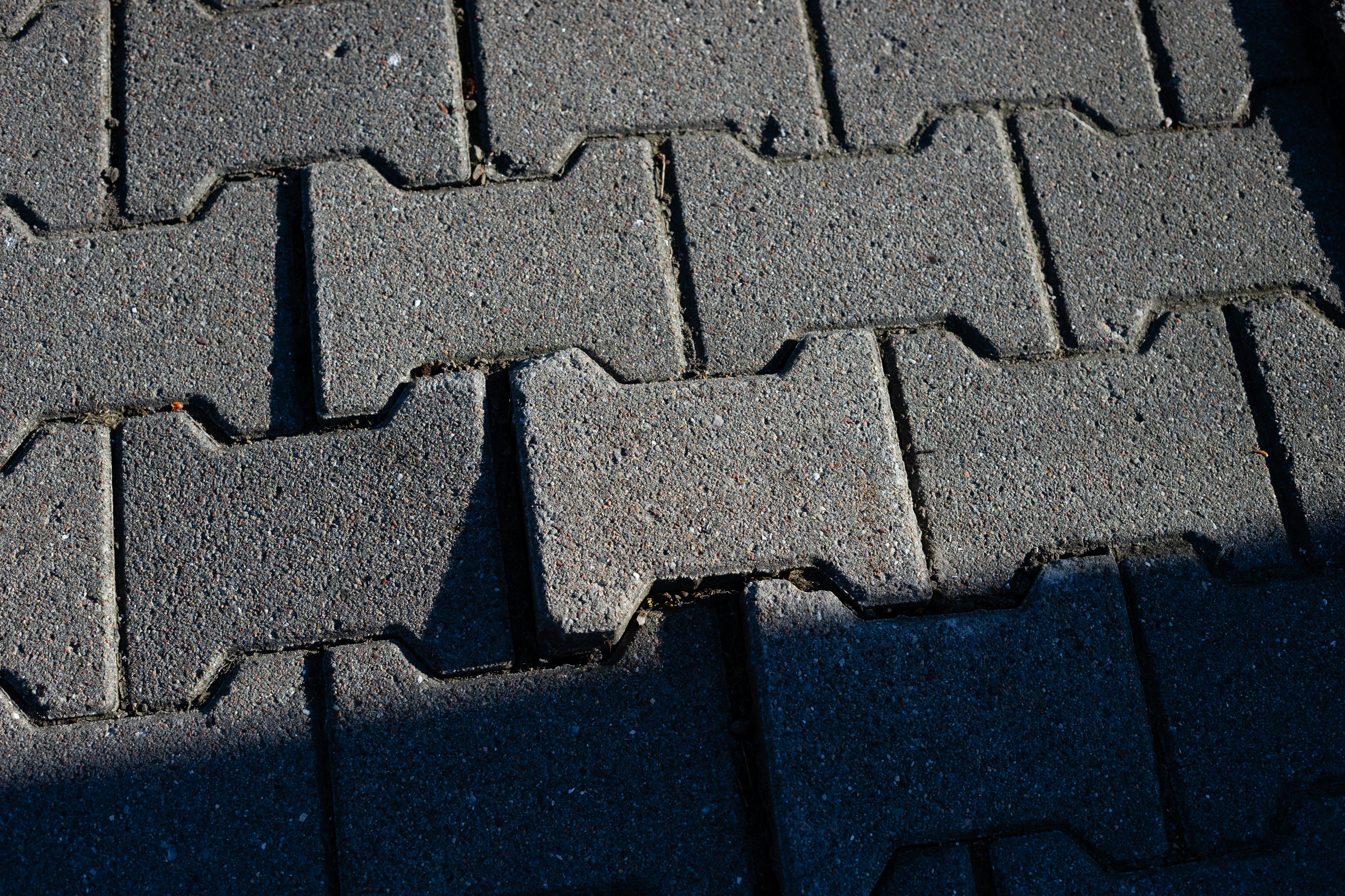 Ridgework in Shadow: Interlocking Asphalt Tiles under Daylight