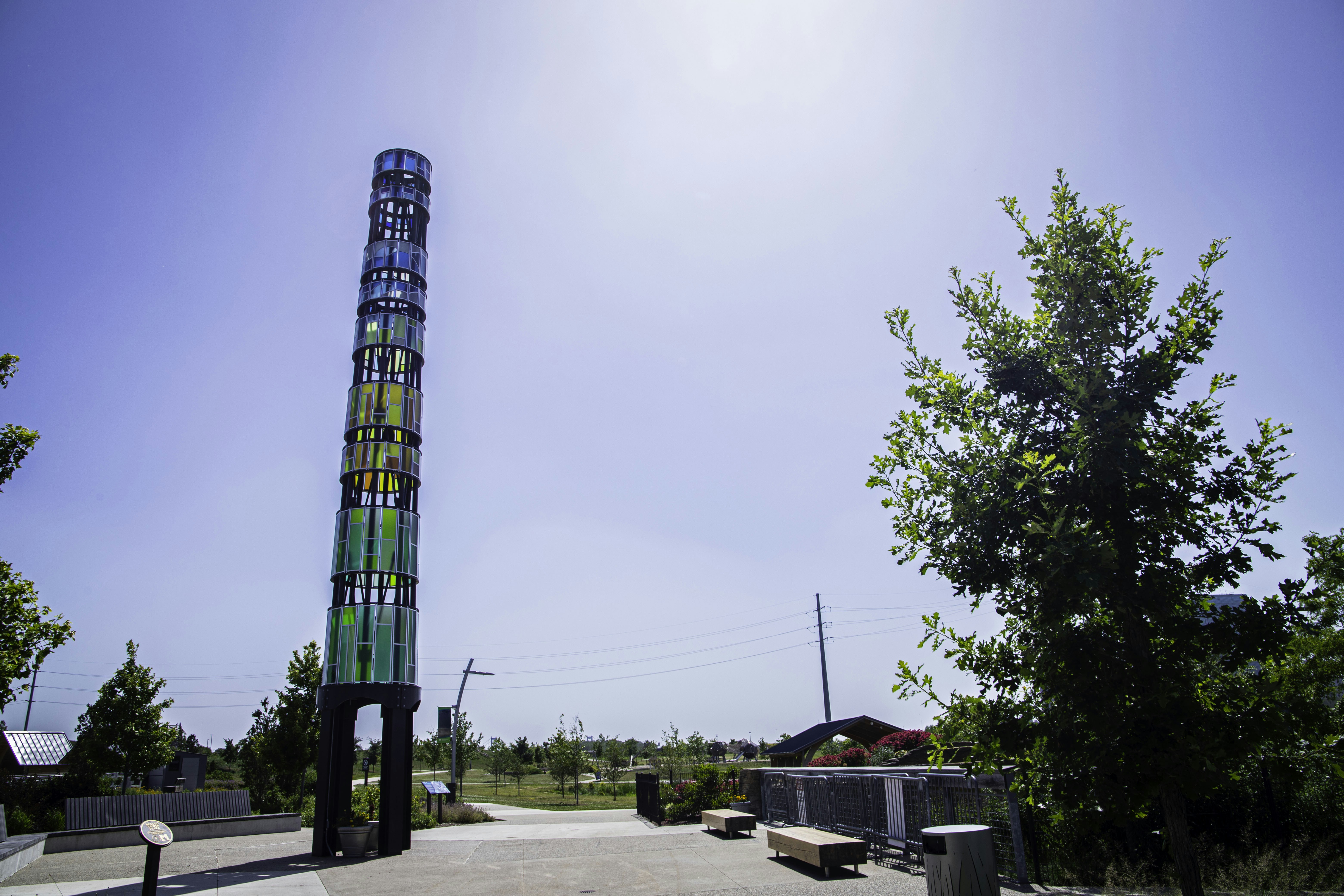 Vertical Kaleidoscope: A Colorful Tower Rising Over a Sunny Plaza