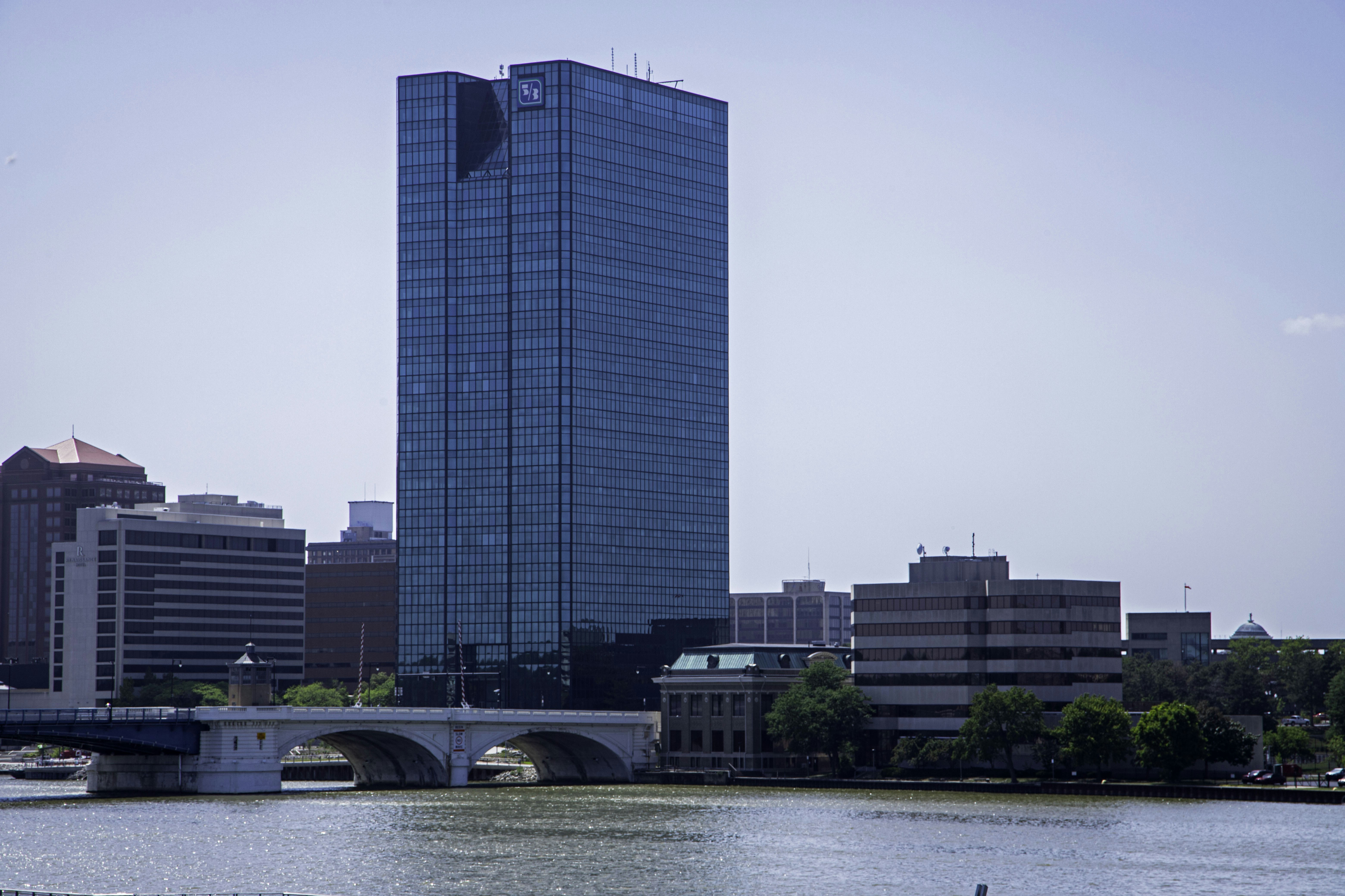 Blue Glass Tower by the River: Urban Oasis Rising