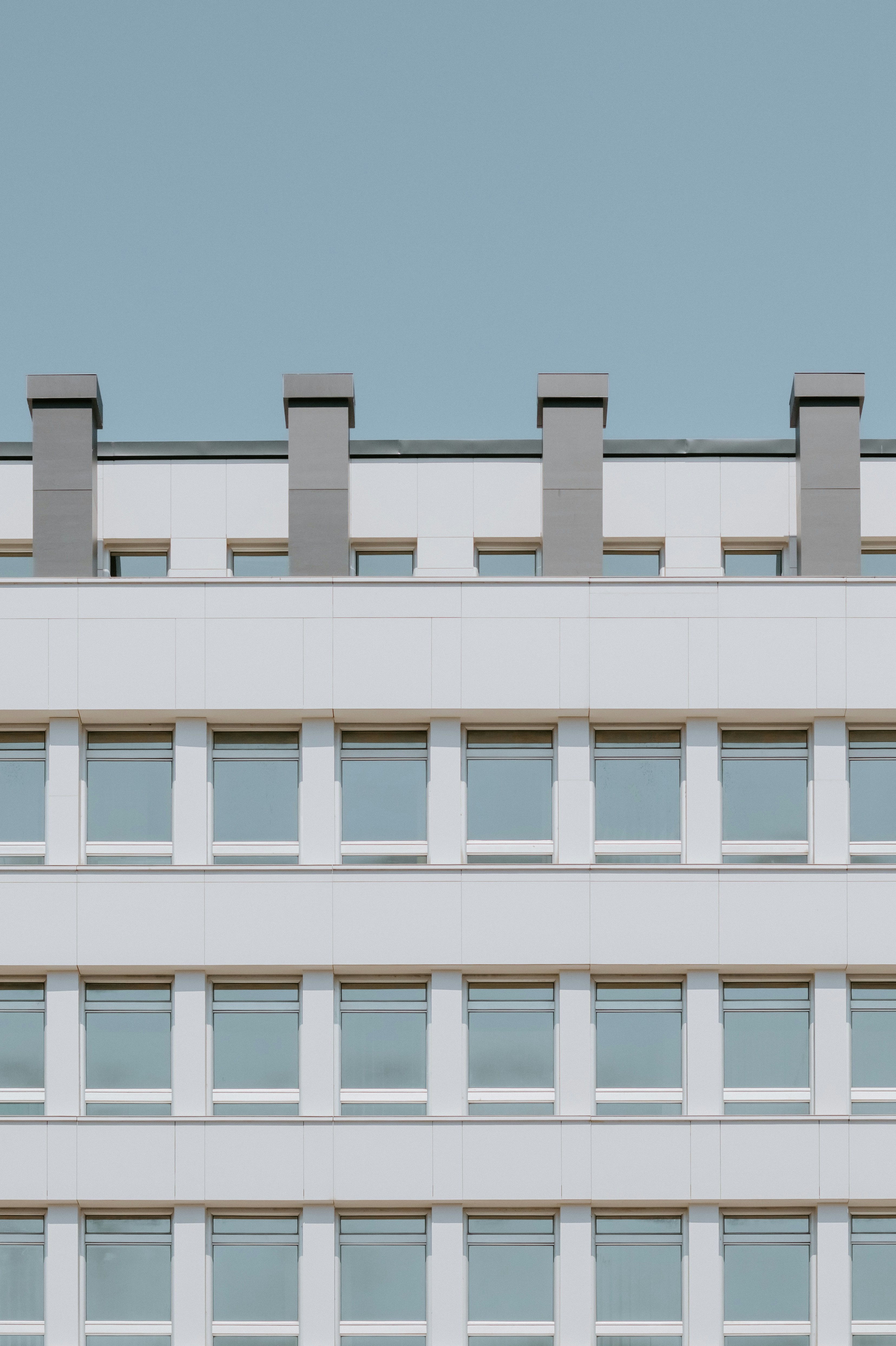 Symmetry Above the City: Vertical Facade Lines and Sky