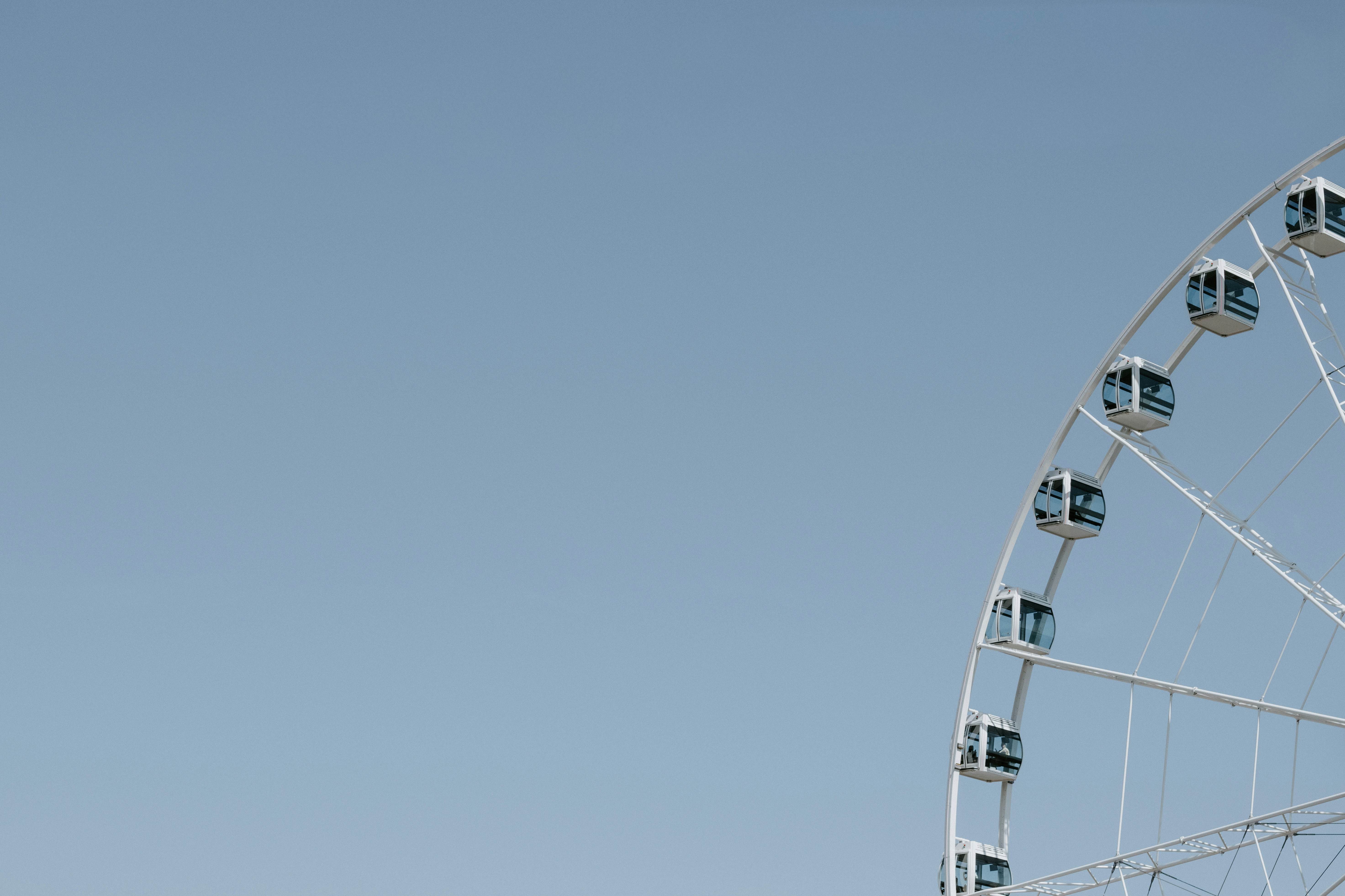 Partial Ferris Wheel: A Sky-Blue Gaze at the Edge of a Large Ride