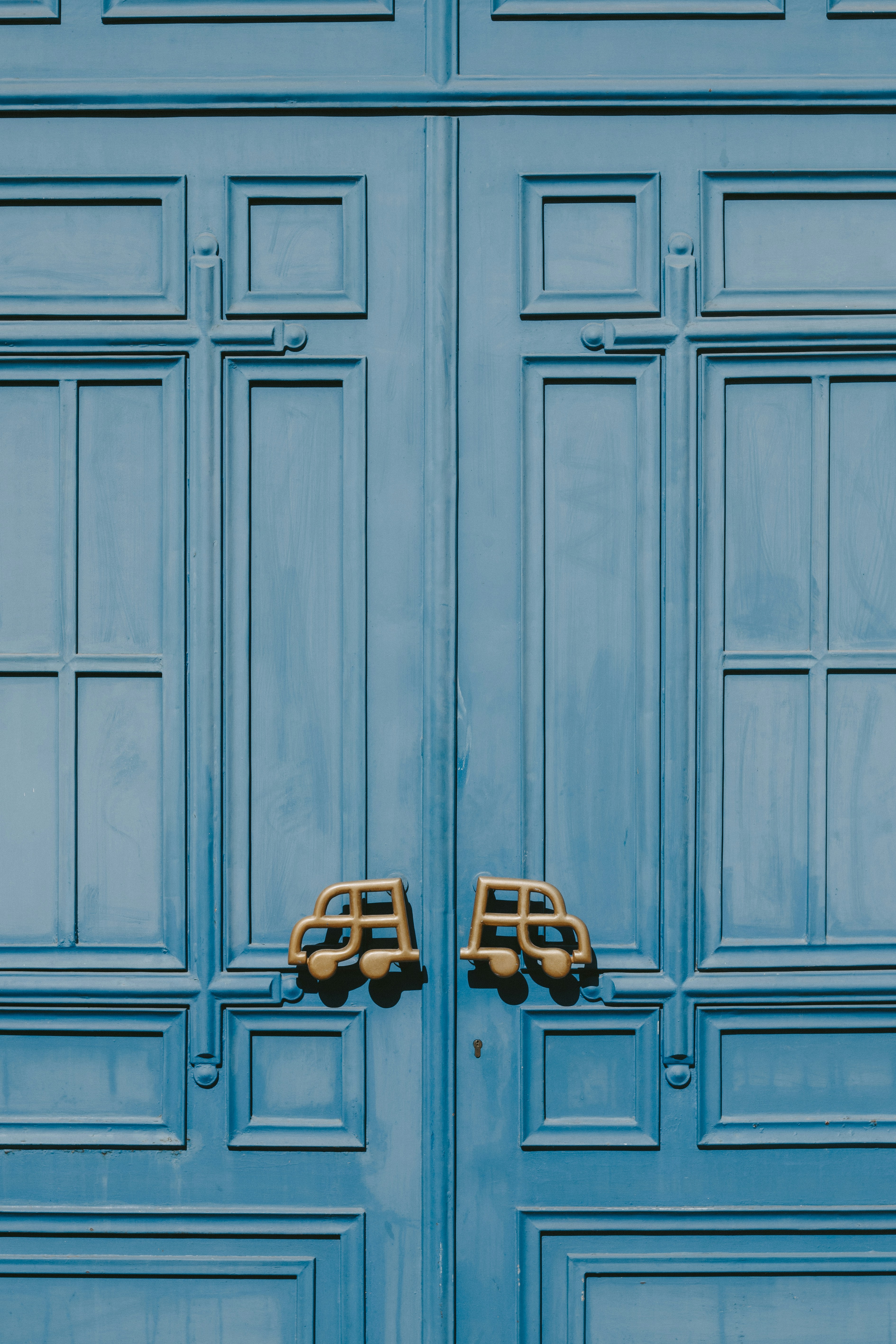 Twin Padlocks on a Blue Door: A Quiet Moment in Metal and Hue