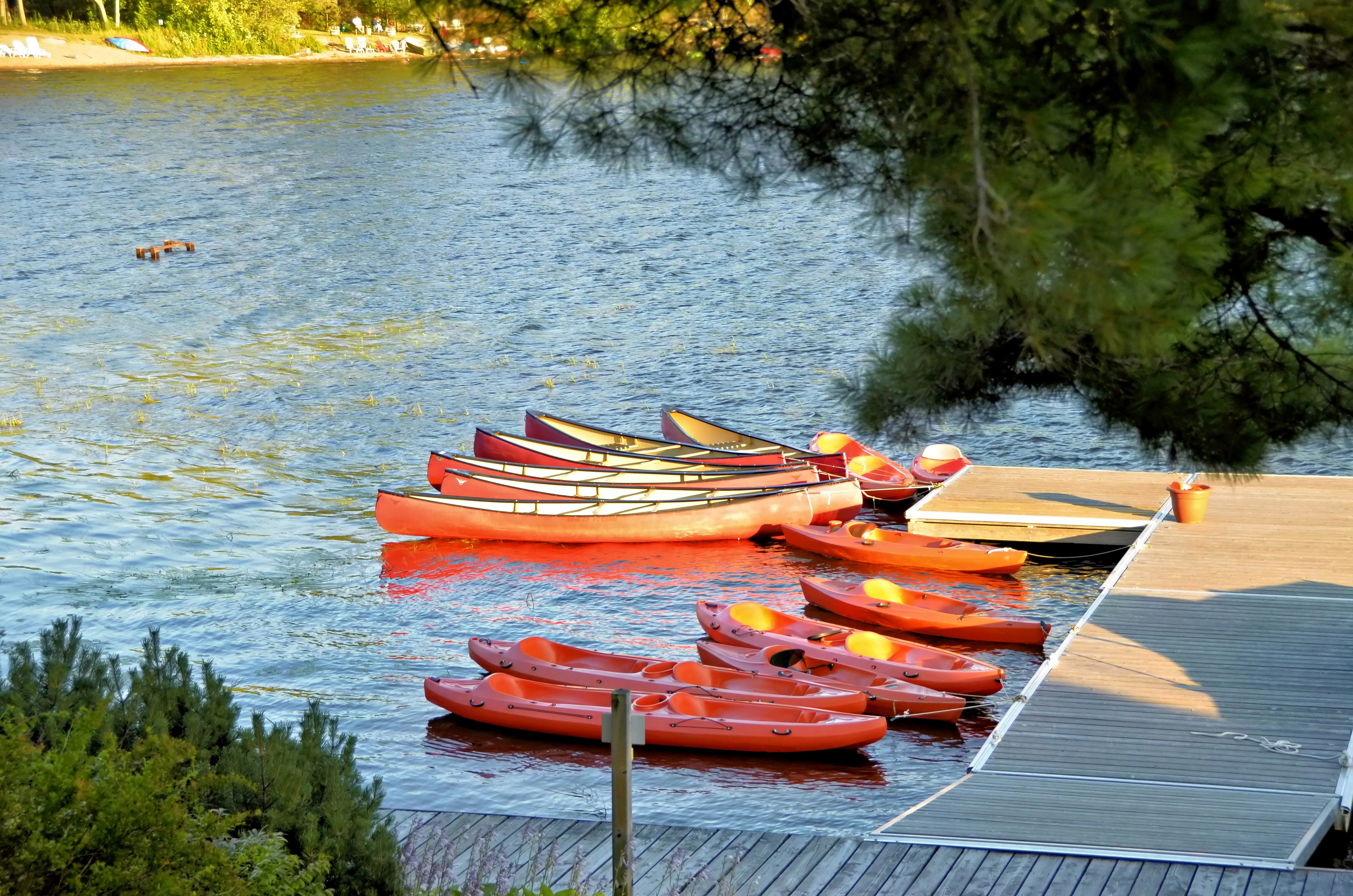 Dockside Red: A Row of Boats Resting Along a Quiet Riverfront