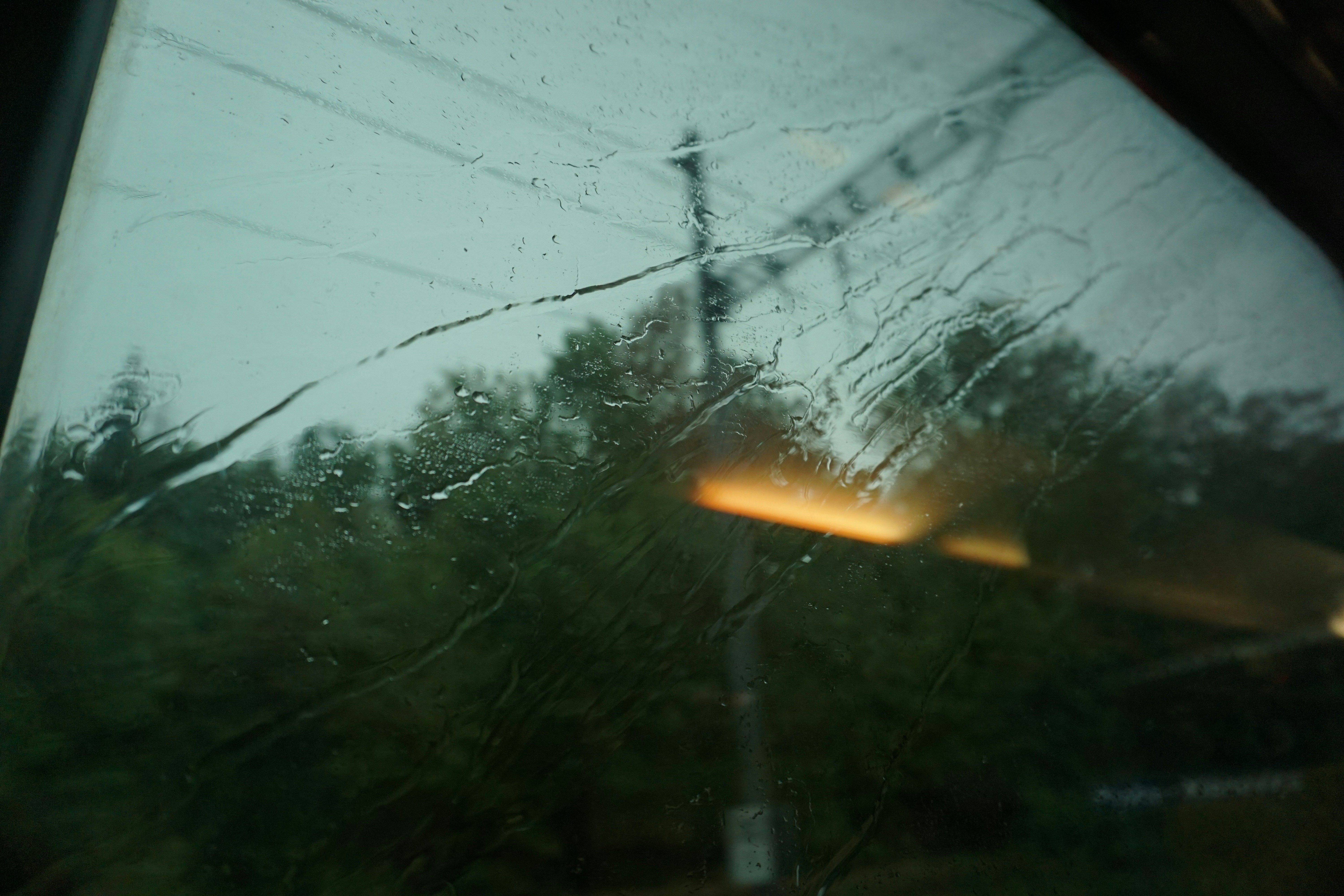 Rain-spattered Window Overcast: Glare of Interior Light Beyond a Static Scene