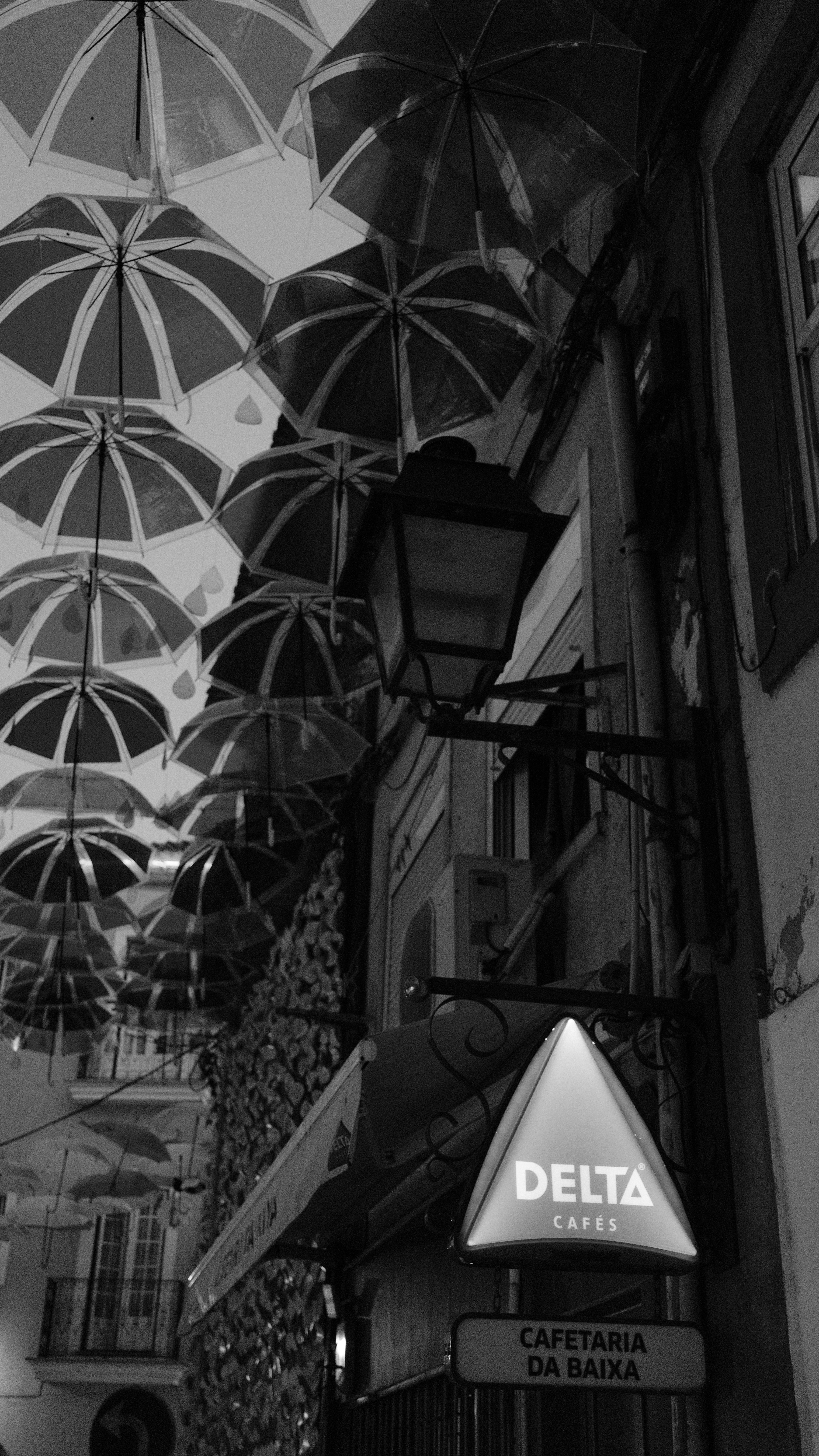 Umbrella Canopy Over a Quaint Café Sign